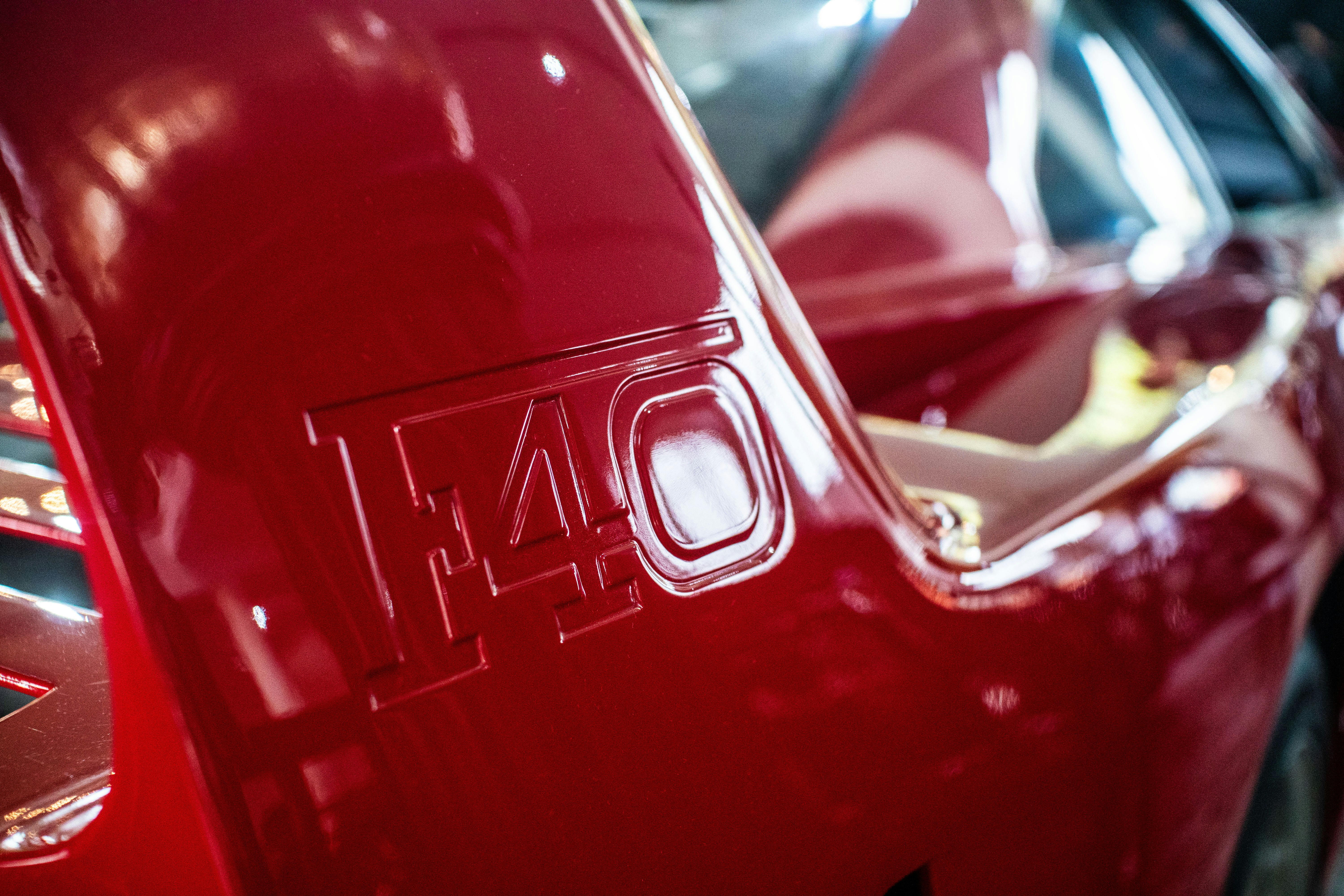 A row of red cars parked next to each other photo – Free Car Image on ...