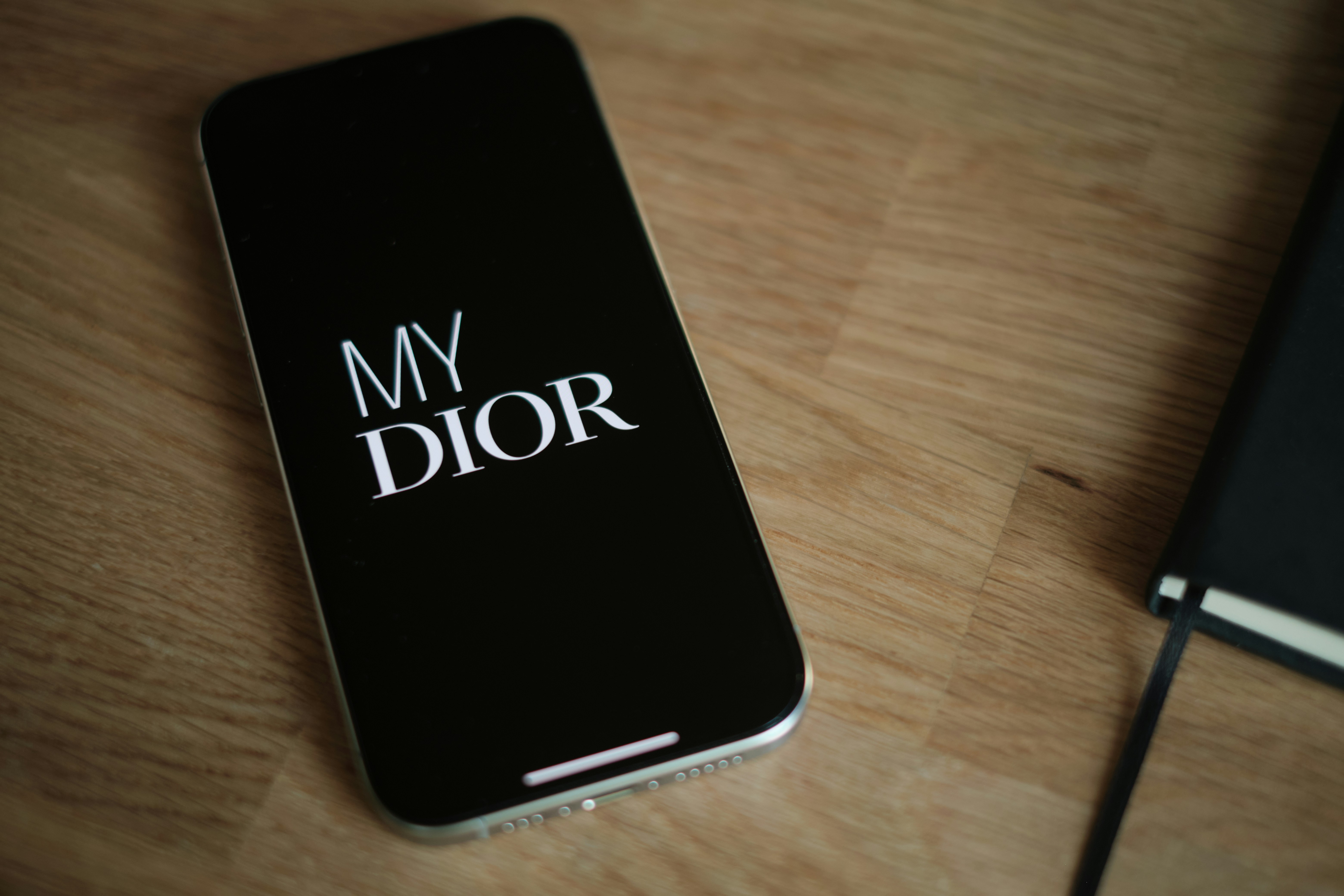 A cell phone sitting on top of a wooden table photo – Free Iphone Image ...