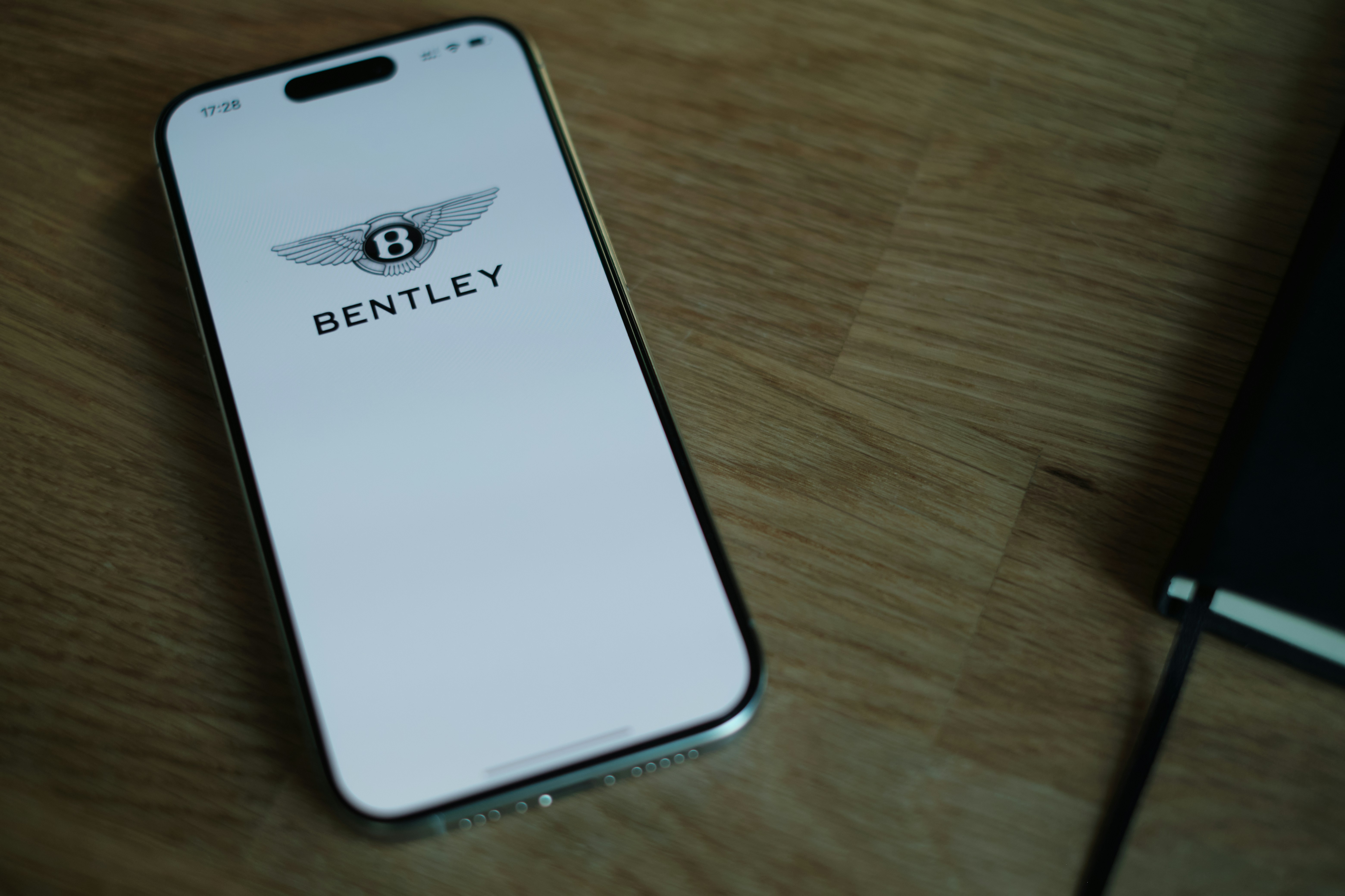 Bentley Emblem on a Quiet Desk Screen: A Minimal Tech Moment