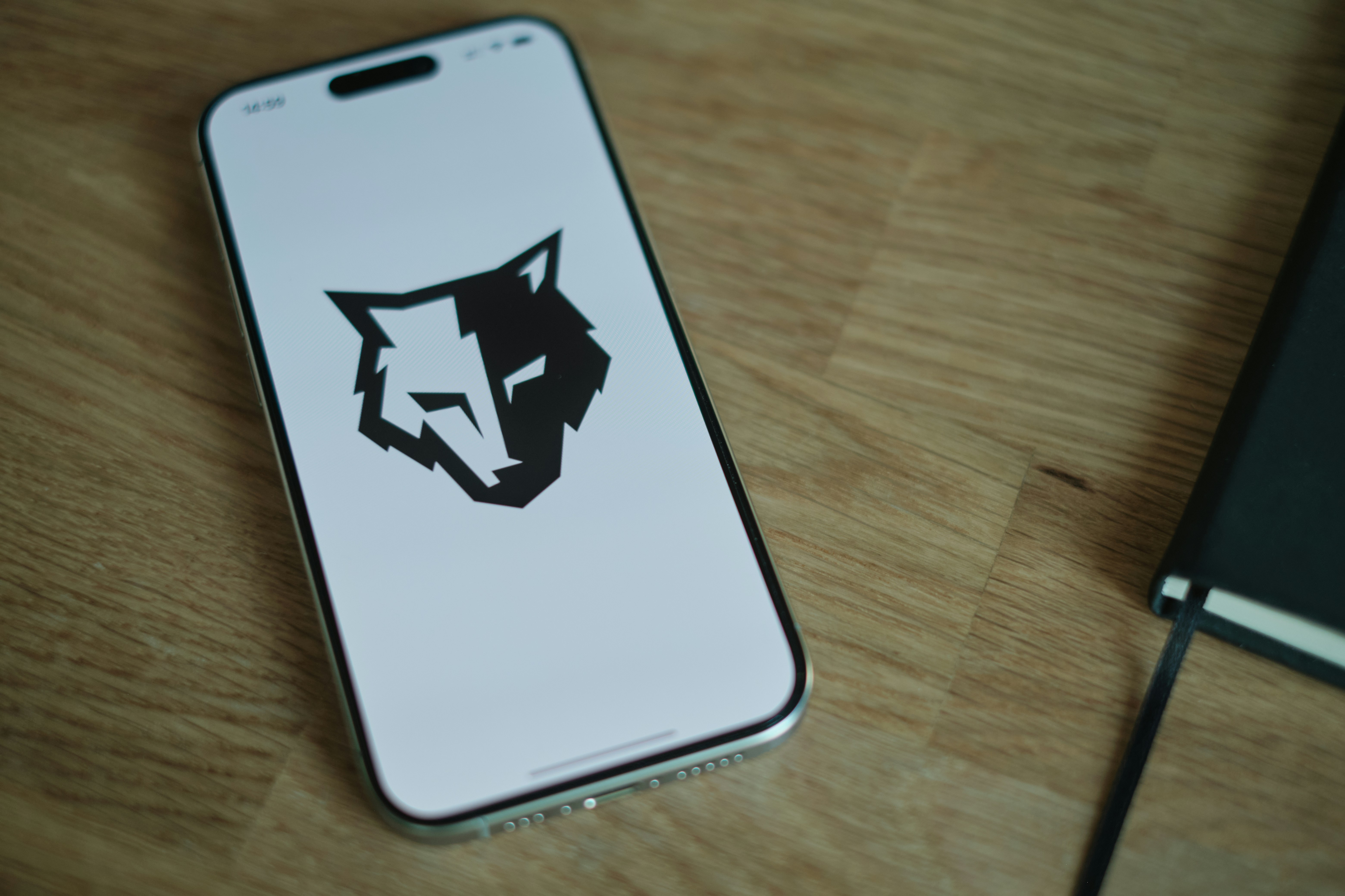 Wolf Emblem on a White Screen: A Quiet Desk Portrait