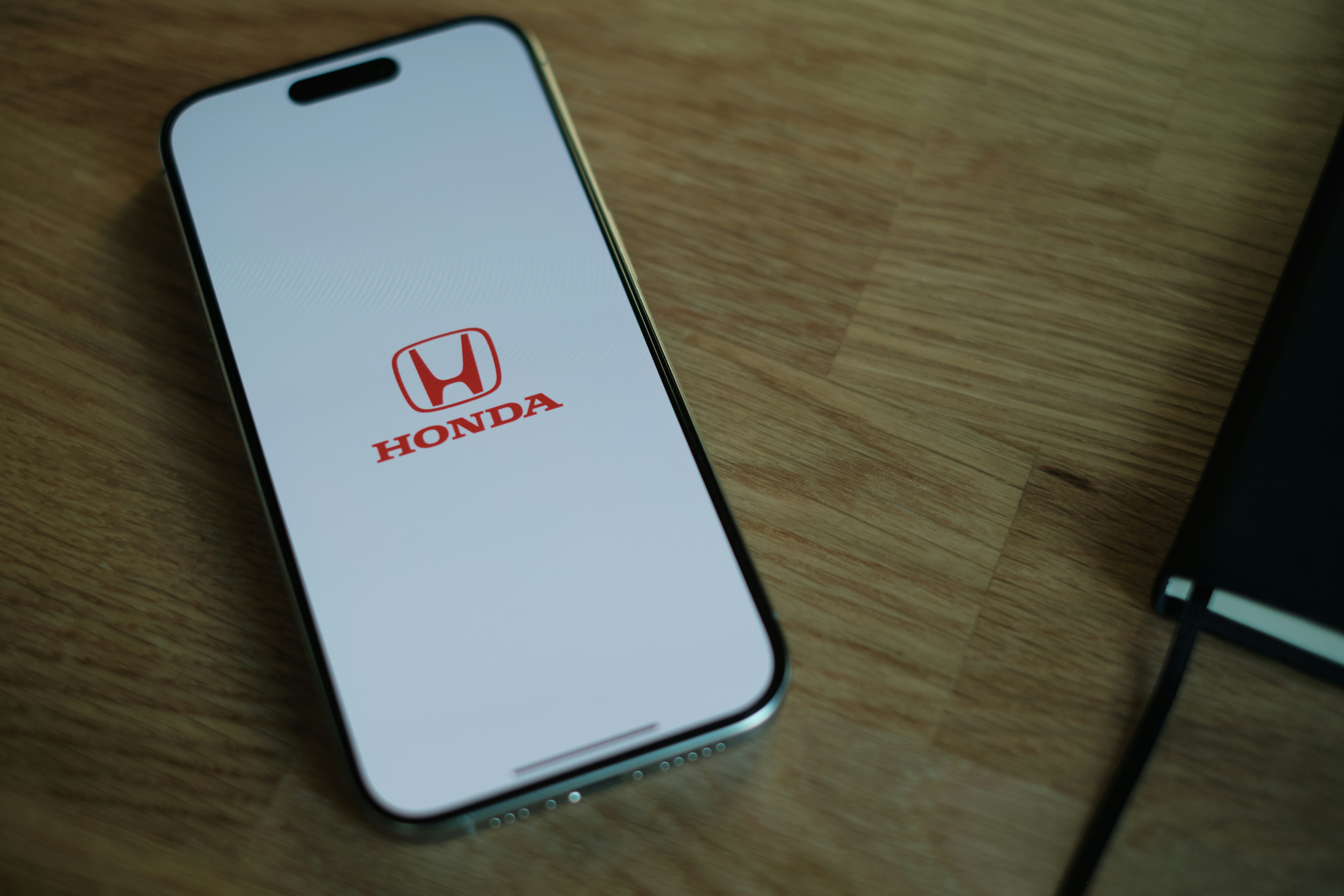 Honda Red Emblem on a White Screen: A Minimal Desk-Top Branding Moment
