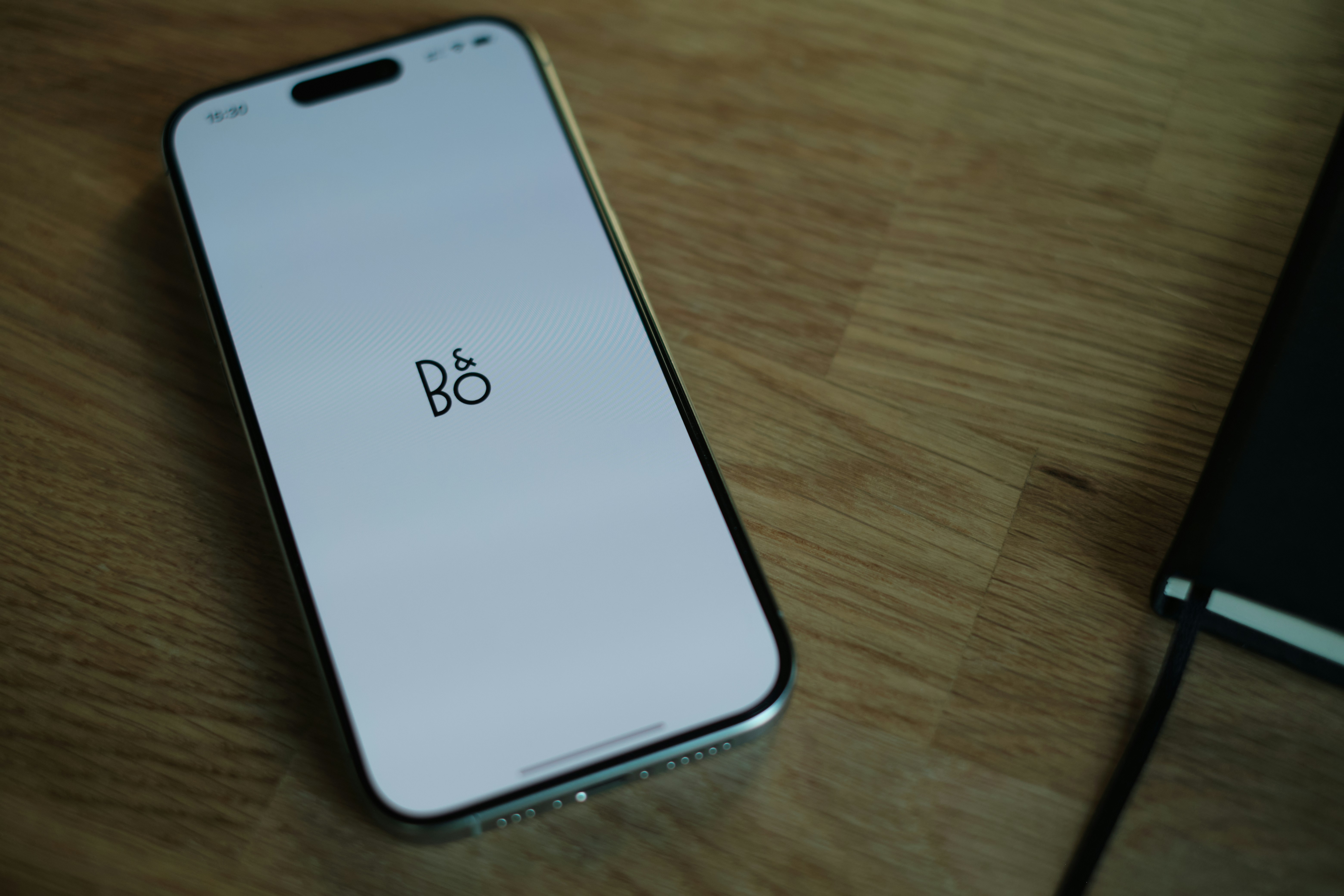 A cell phone sitting on top of a wooden table photo – Free Iphone Image ...