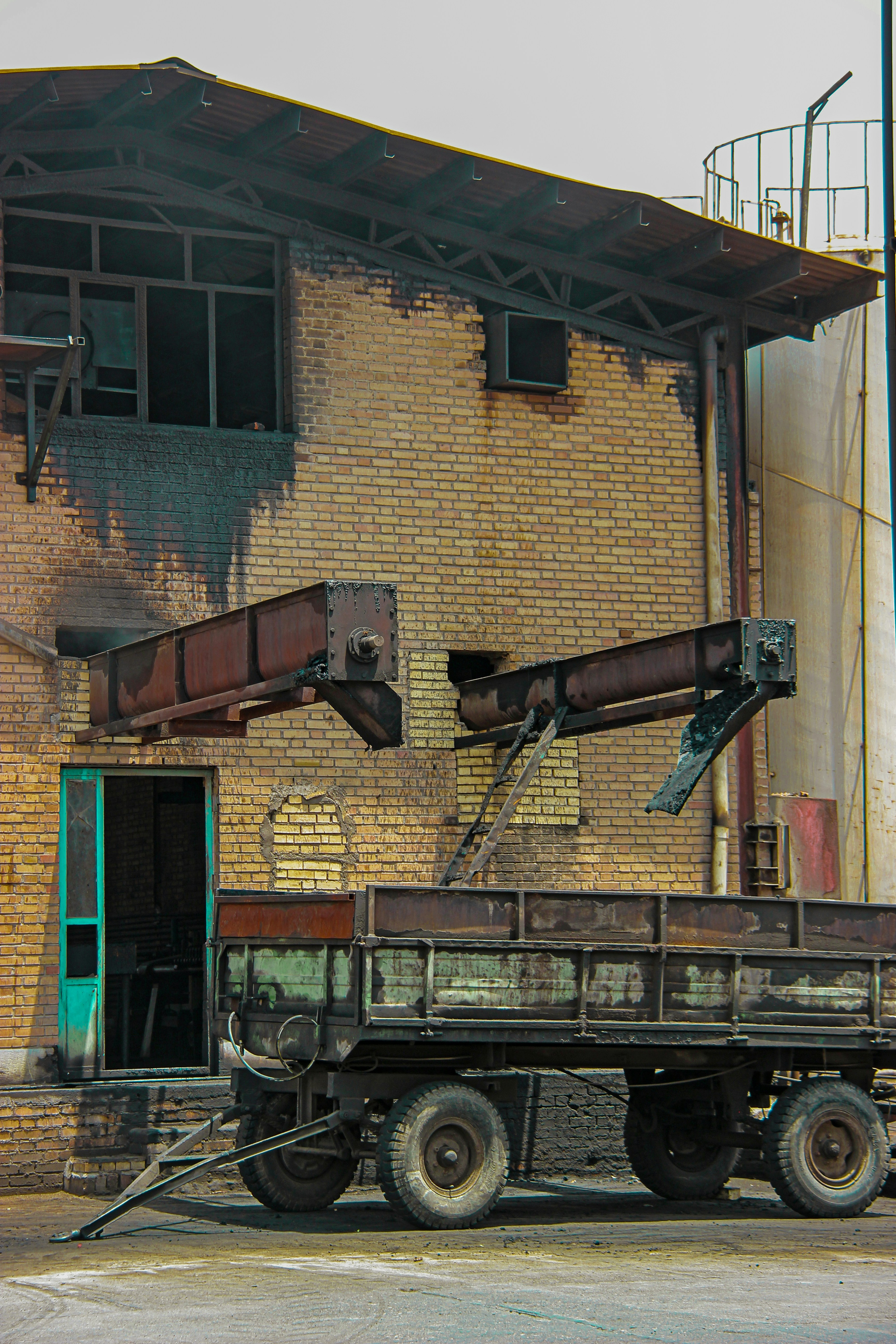 Rust, Brick, and Turquoise: An Idle Industrial Yard in Focus