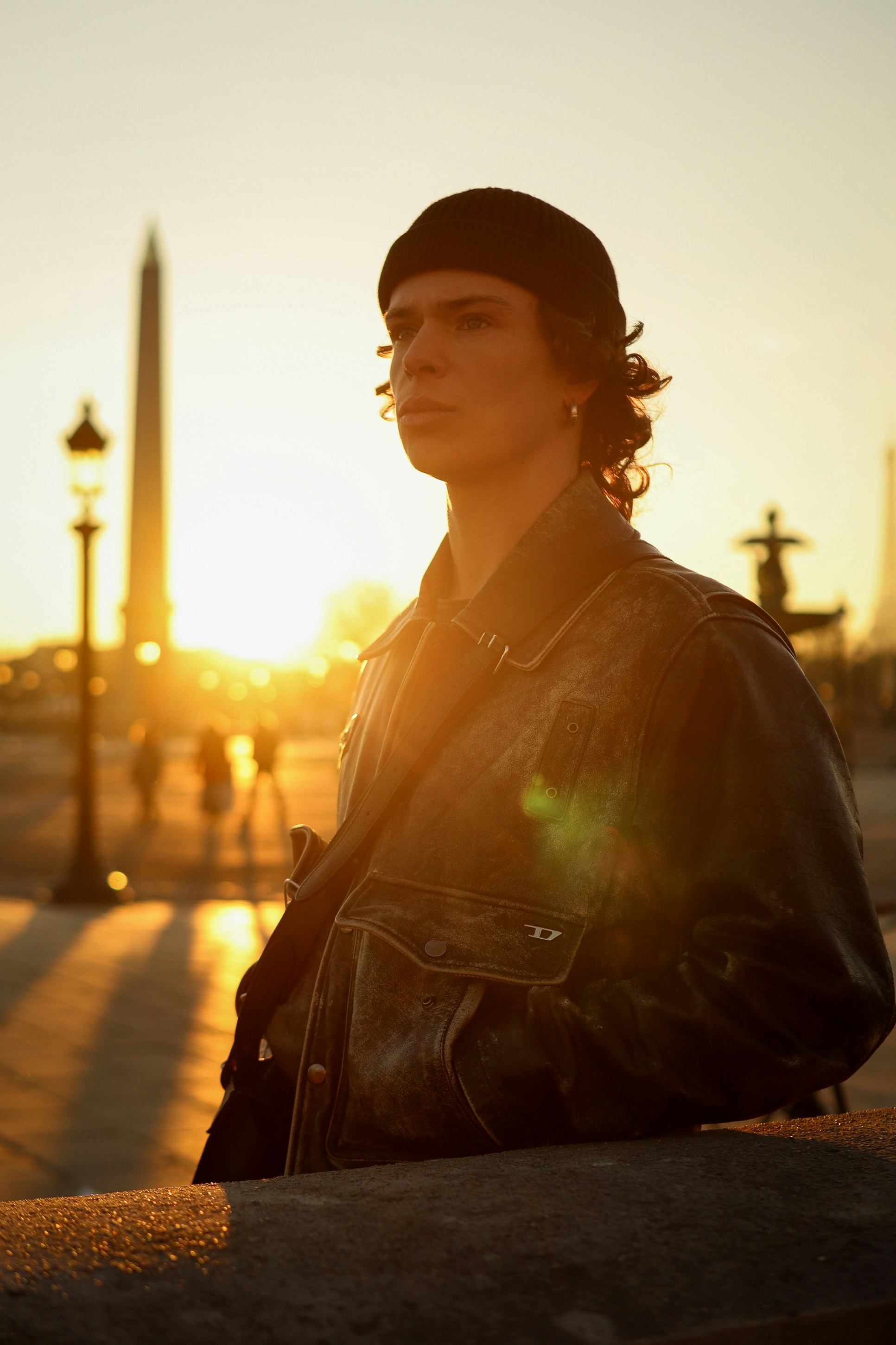 Golden Hour Gaze by the Obelisk: A Denim Jacket Portrait at Sunset