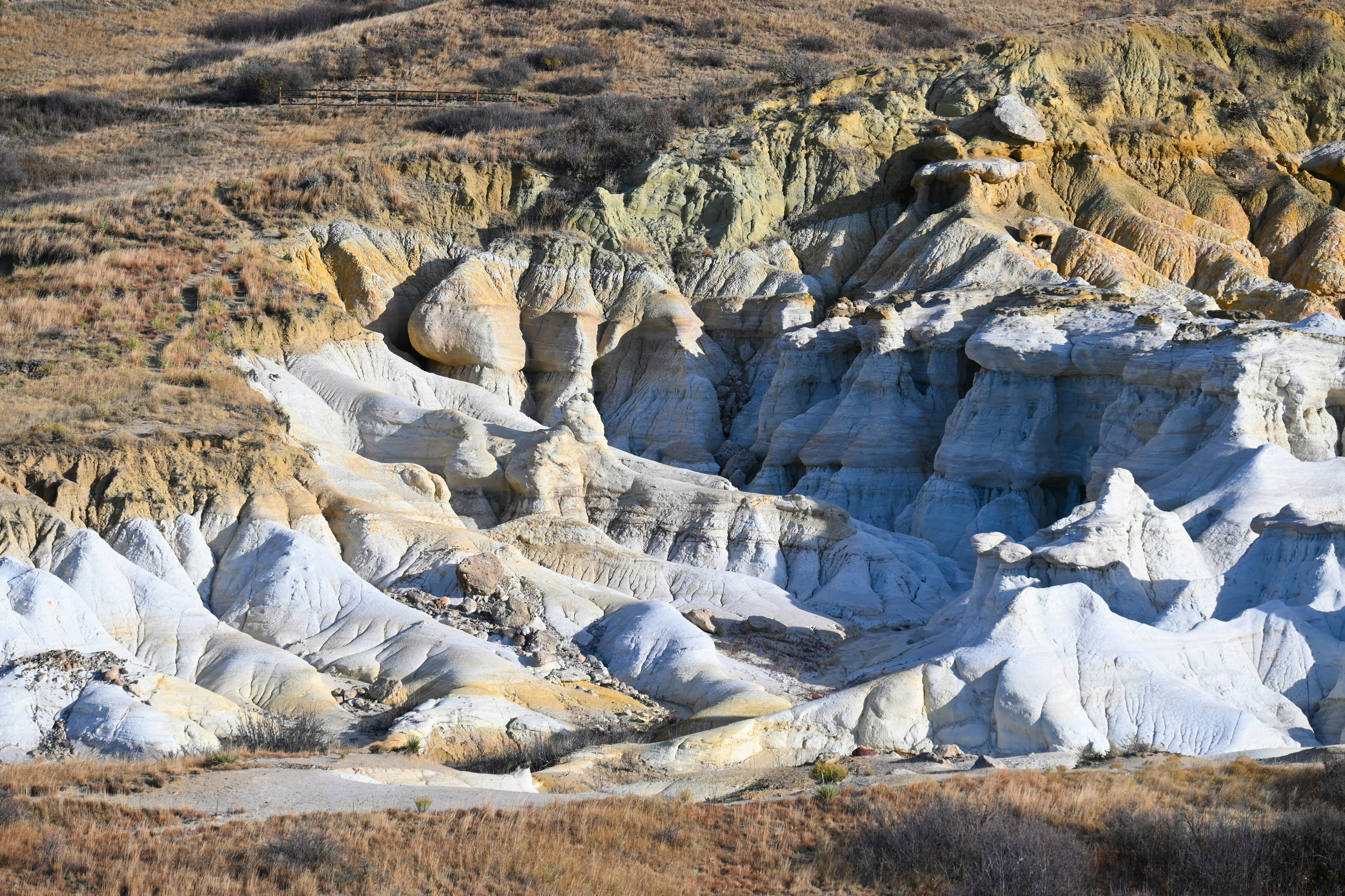 A large group of rocks in a dry grass field photo – Free Paint mines ...