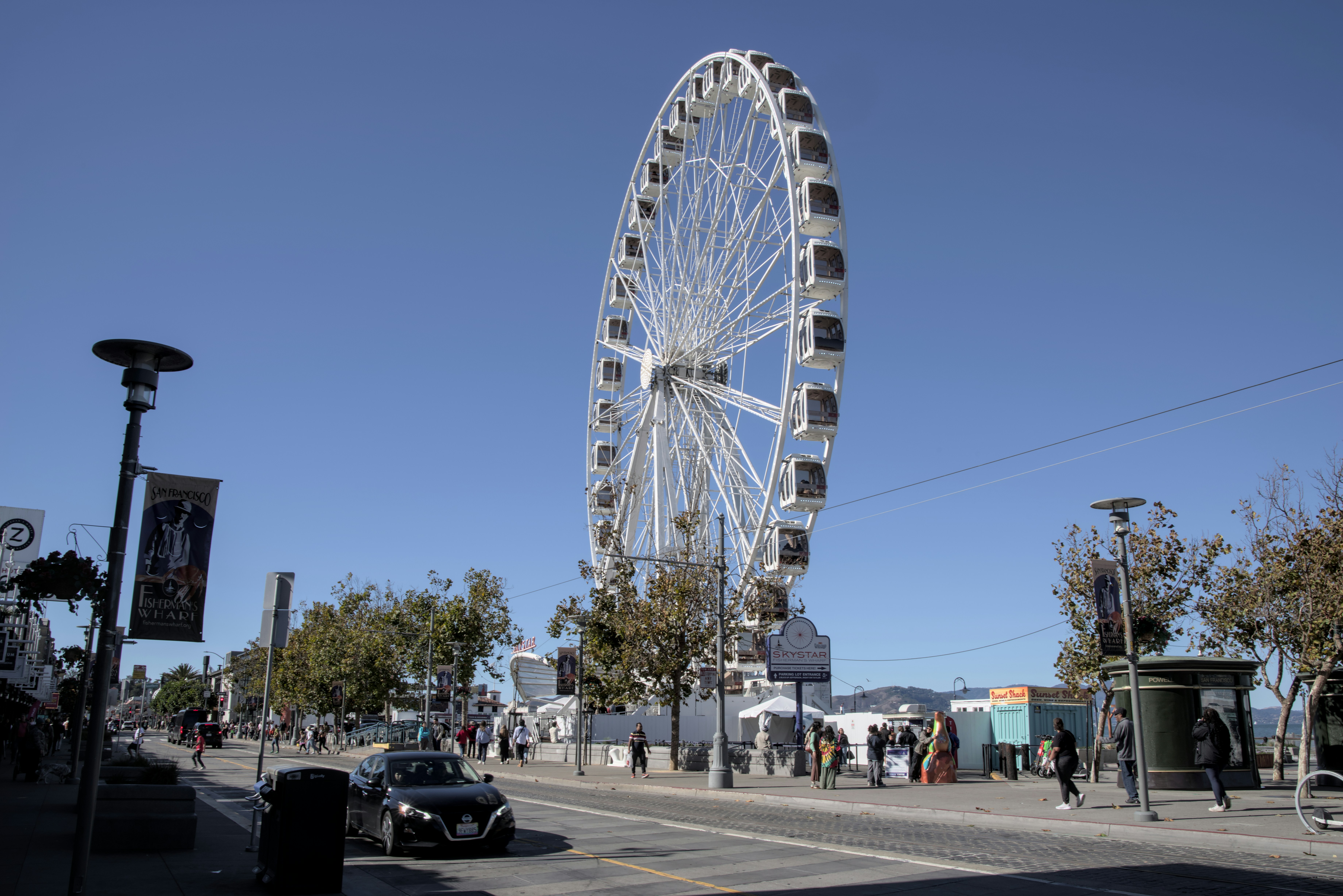 Giant Ferris Wheel Framing a Coastal City Square