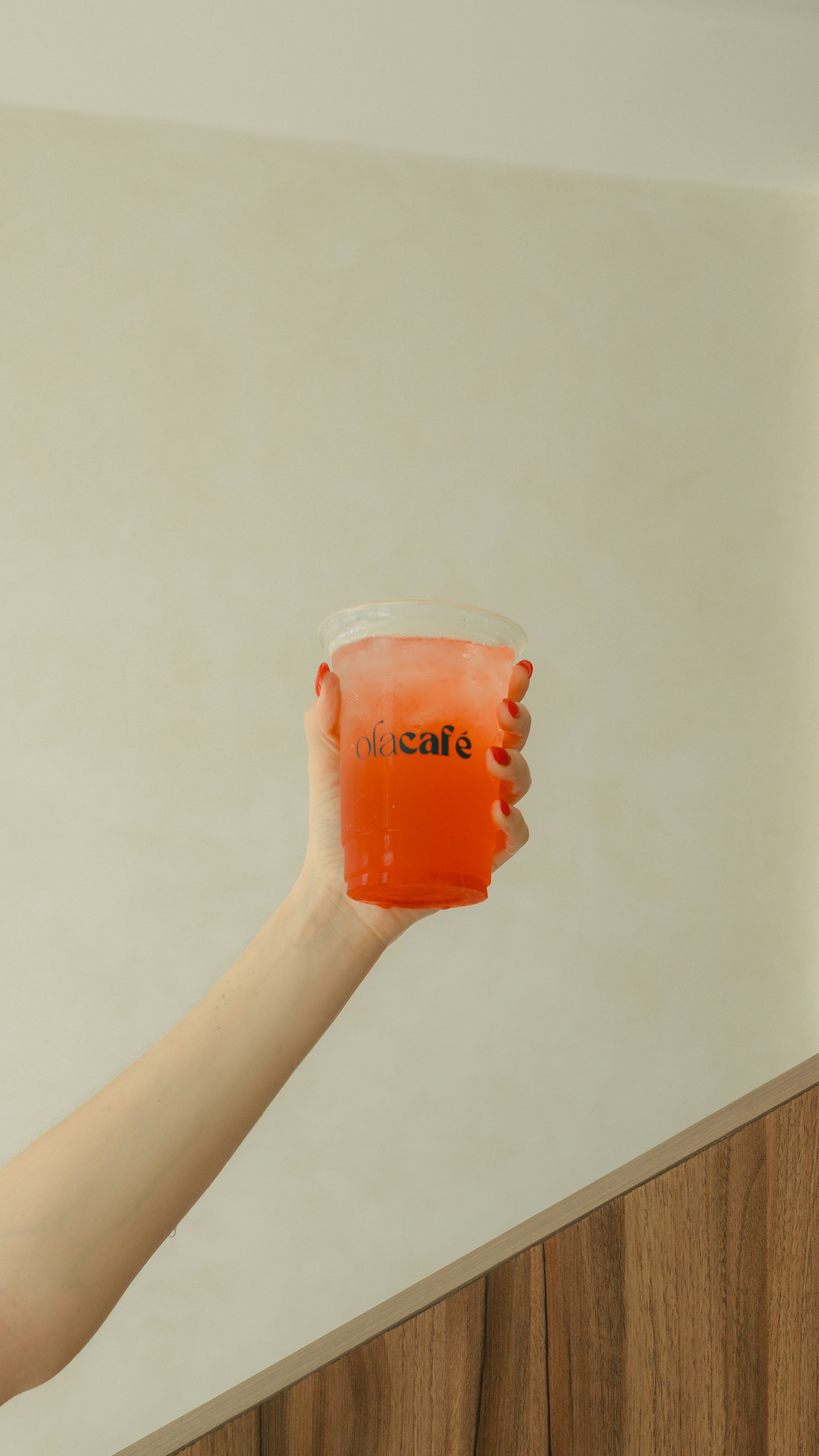 Citrus in Hand: A Minimal Orange Cup Against a Quiet Backdrop