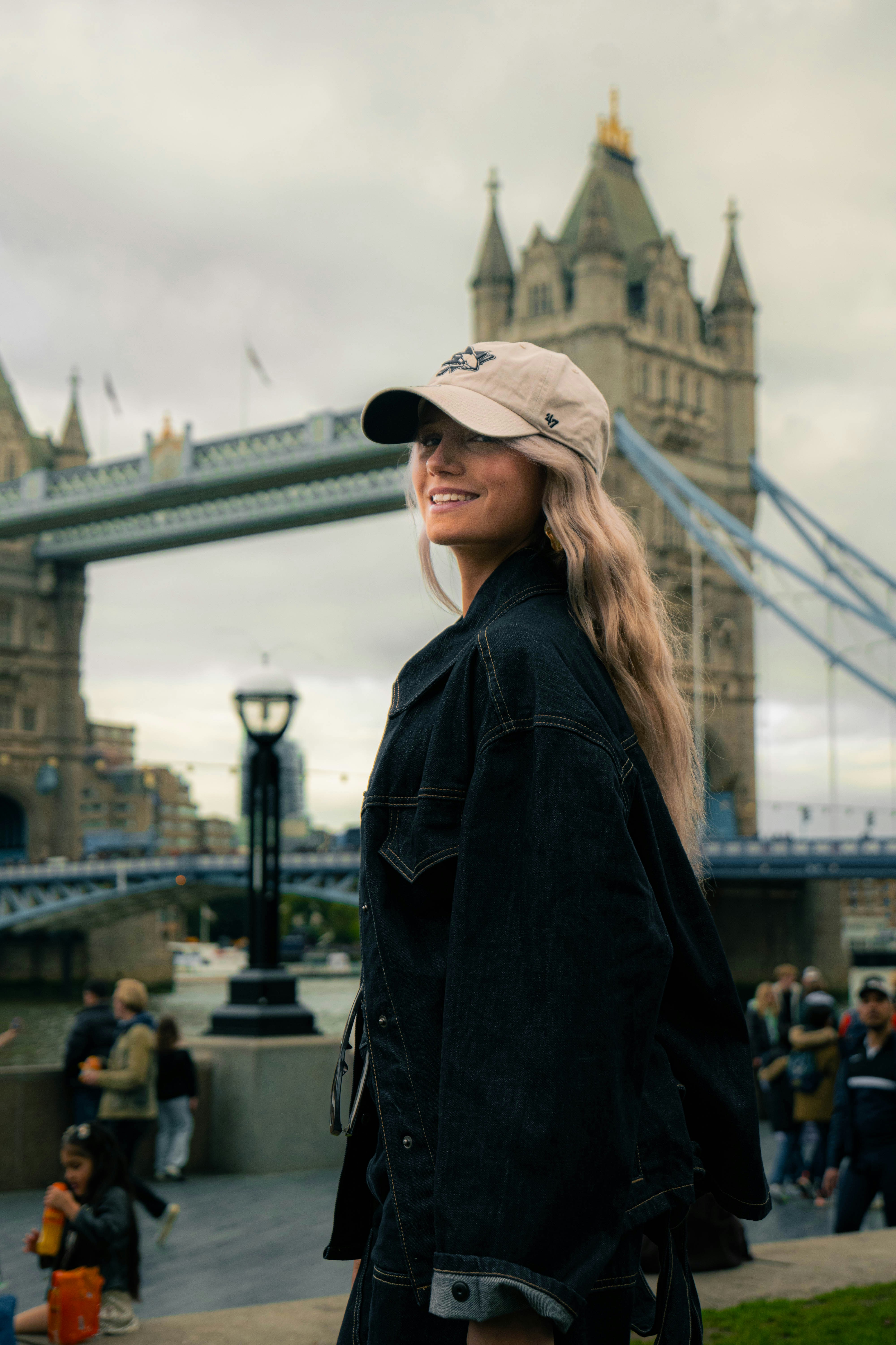 A woman standing in front of a bridge photo – Free Child Image on Unsplash