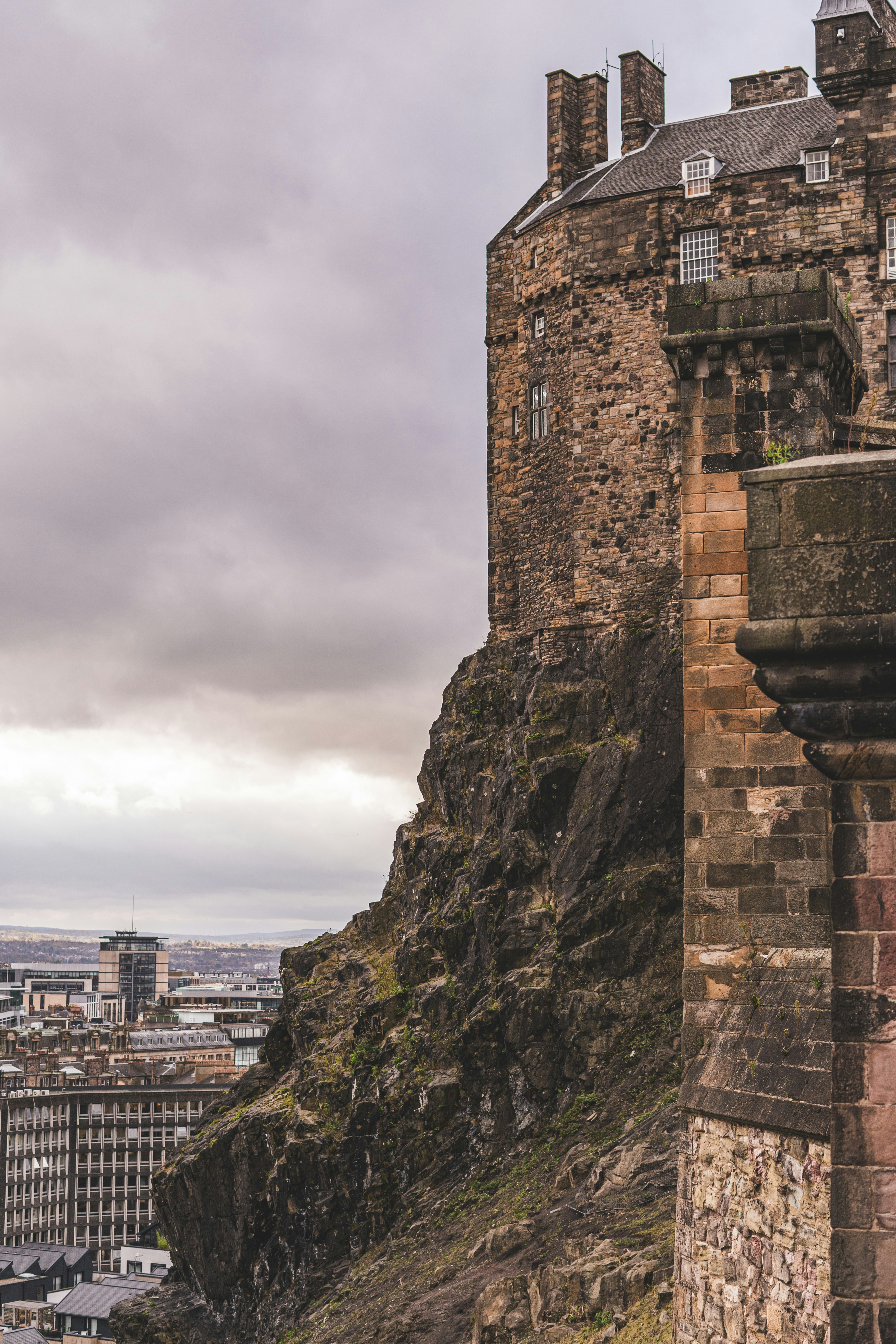 A tall castle sitting on top of a lush green hillside photo – Free ...