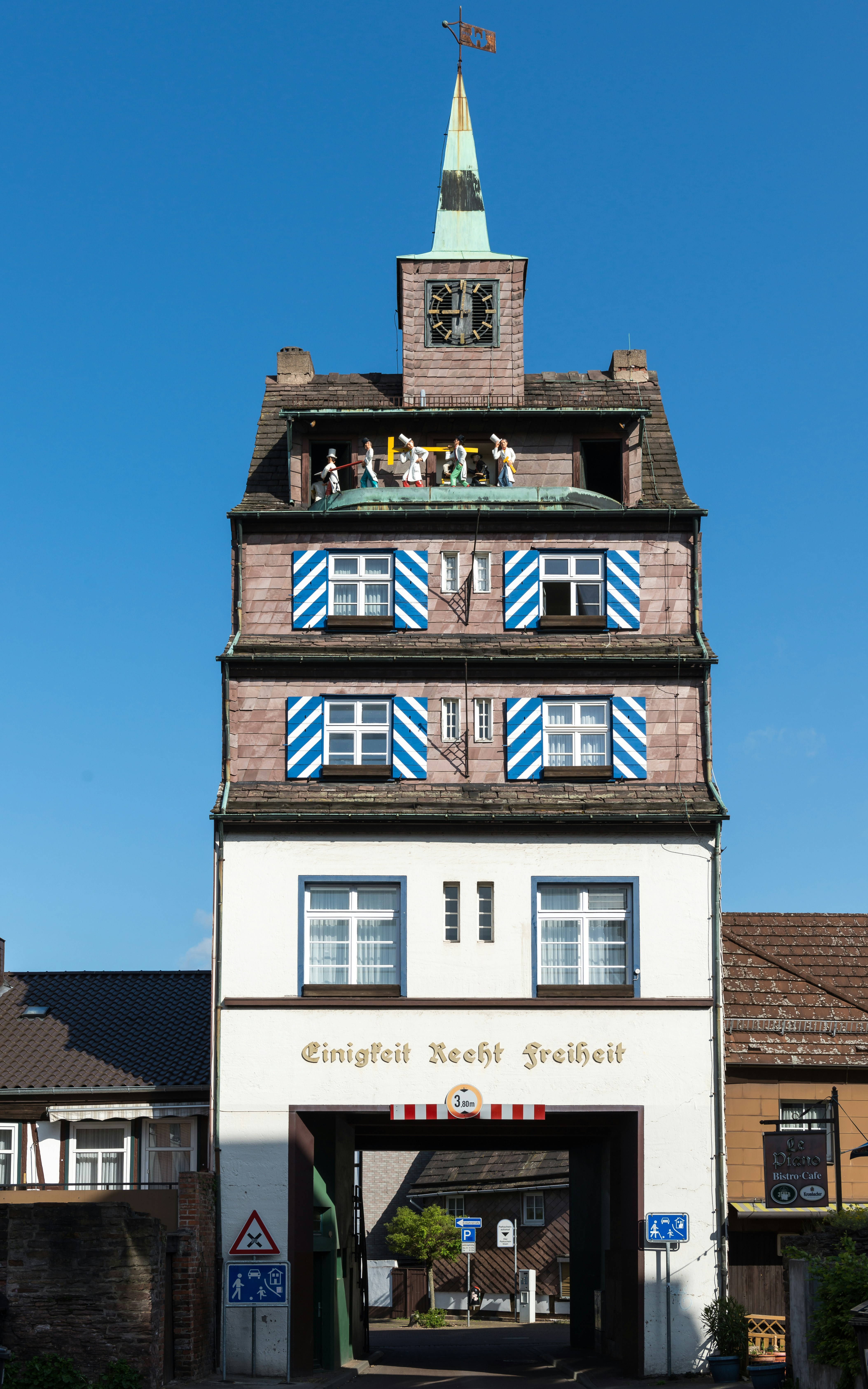 A Timeless Gate: Blue-Shuttered Turrets, Clock Tower, and Onlookers