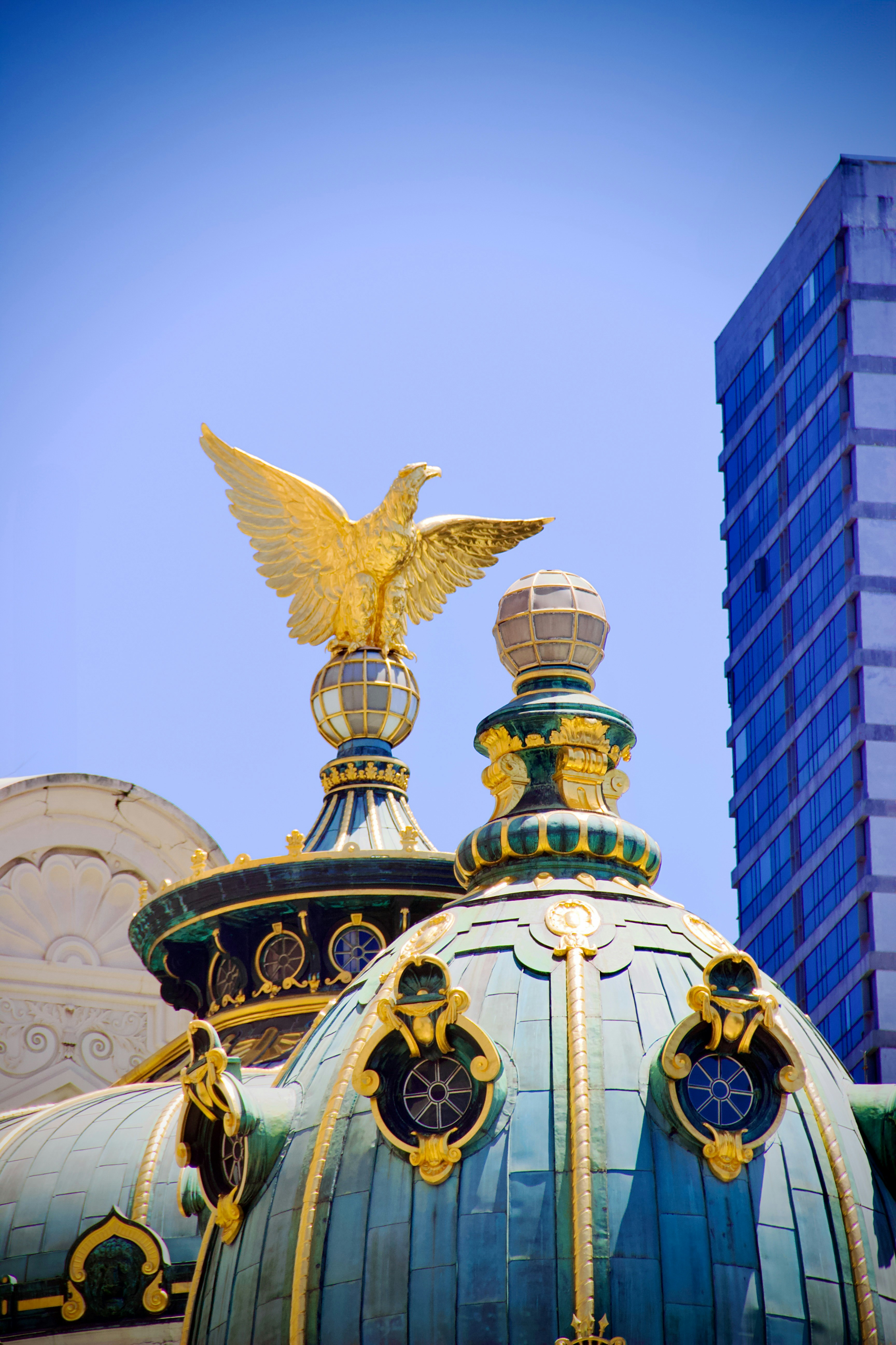 Golden Sentinel Above a Turquoise Dome