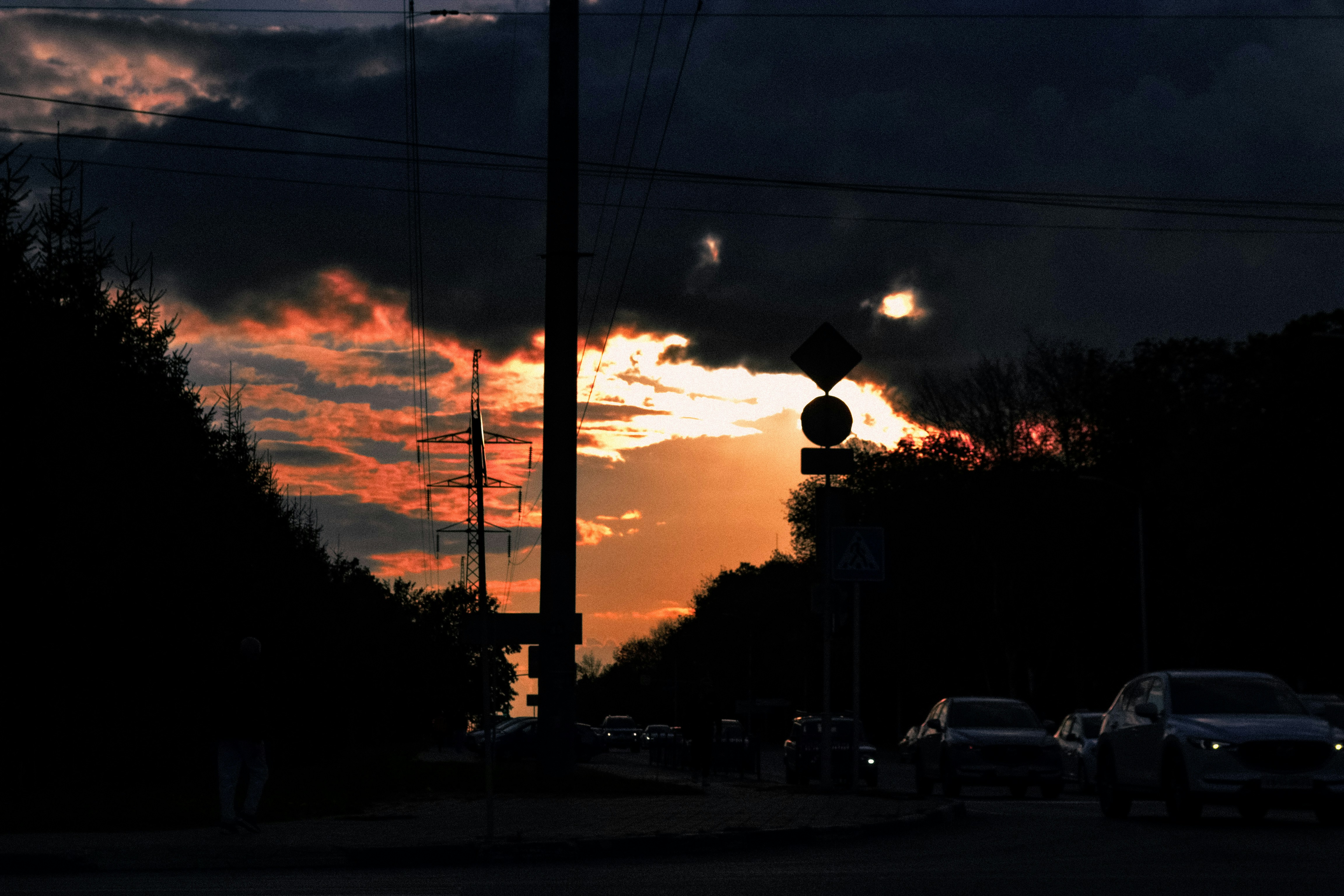 Horizon Glow Behind a Suburban Crossroad at Dusk