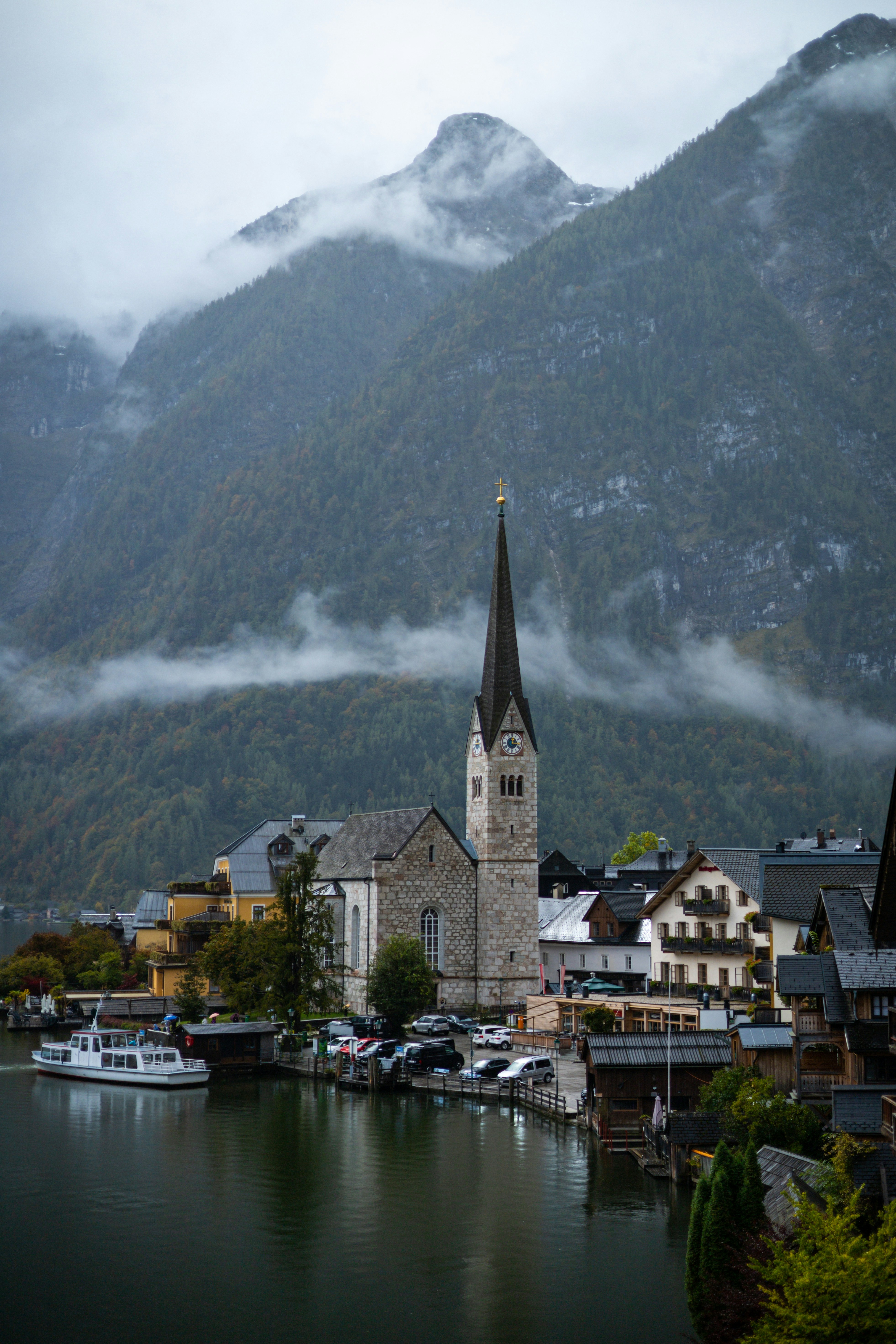 A small town on a lake with mountains in the background