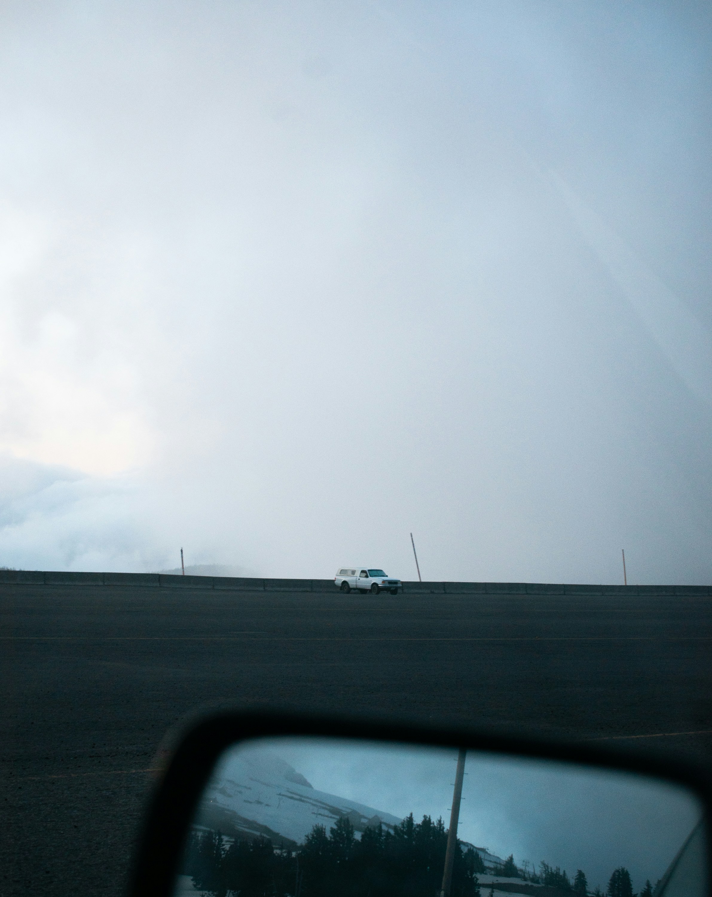 A rear view mirror of a car on a road photo – Free Car Image on Unsplash