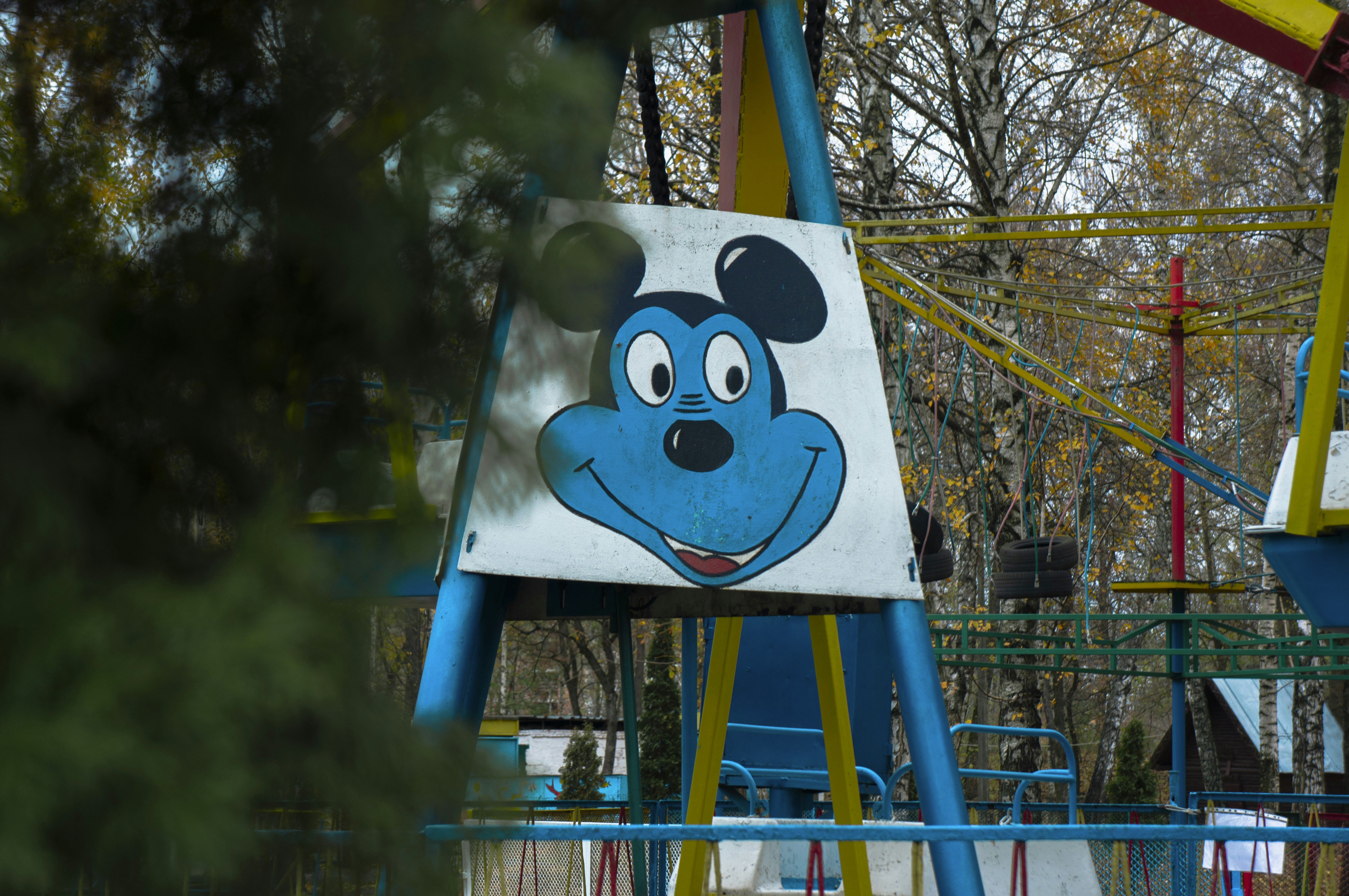 Blue Mouse on a Colorful Playground Sign