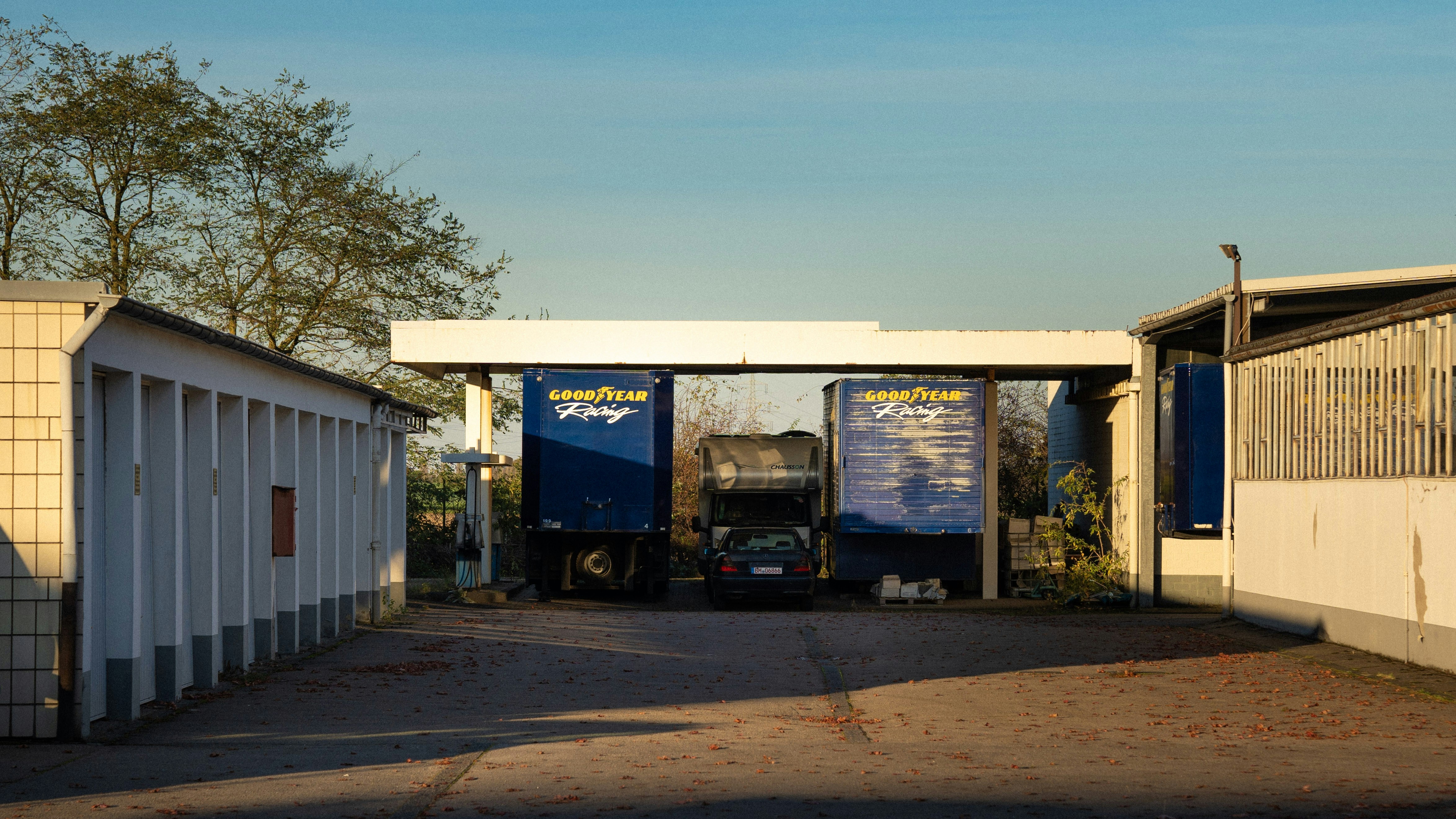 A truck is parked in front of a storage building