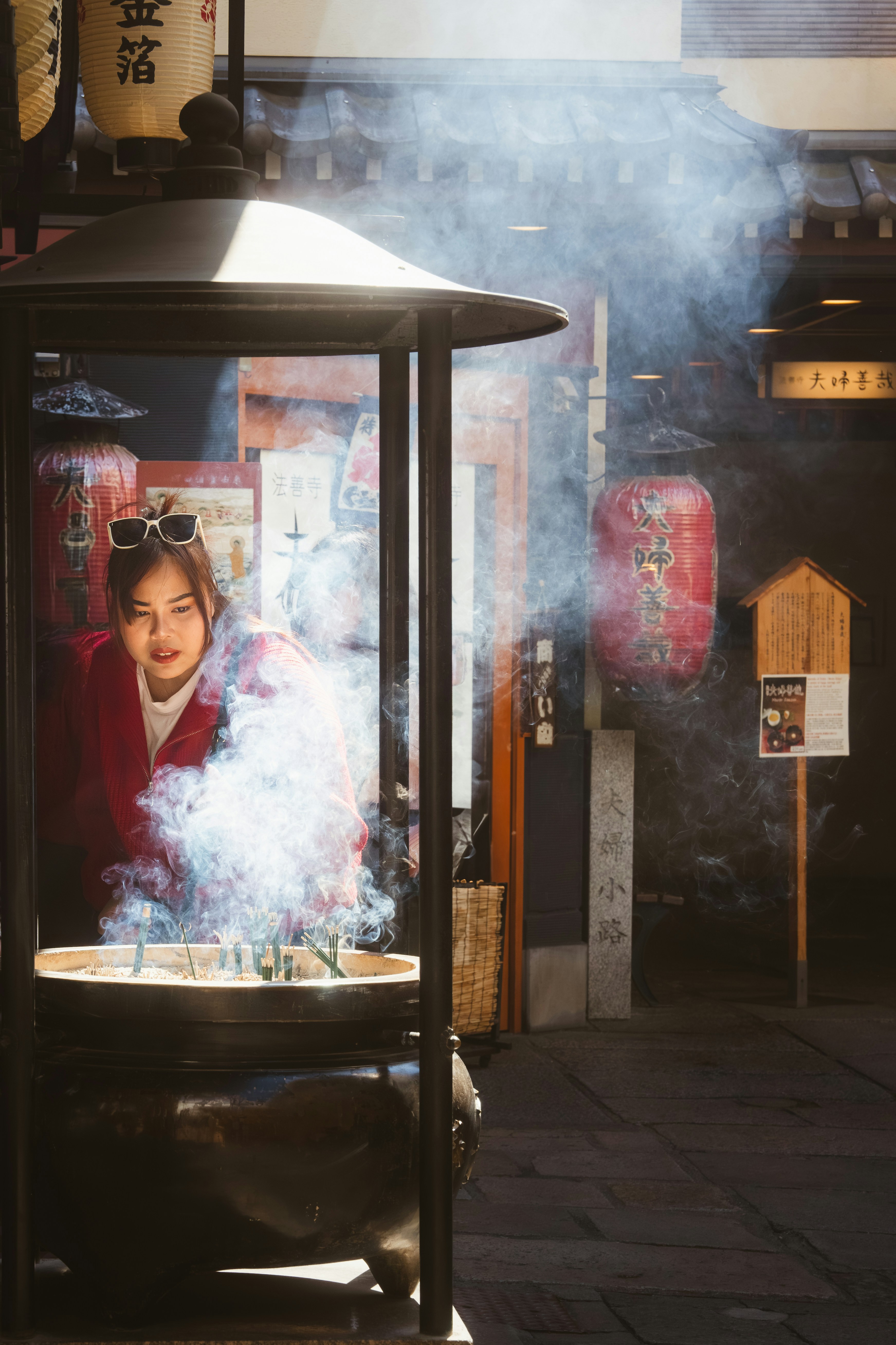 Red-Garbed Quiet at a Smoky Incense Burner in a Lantern-Lit Temple