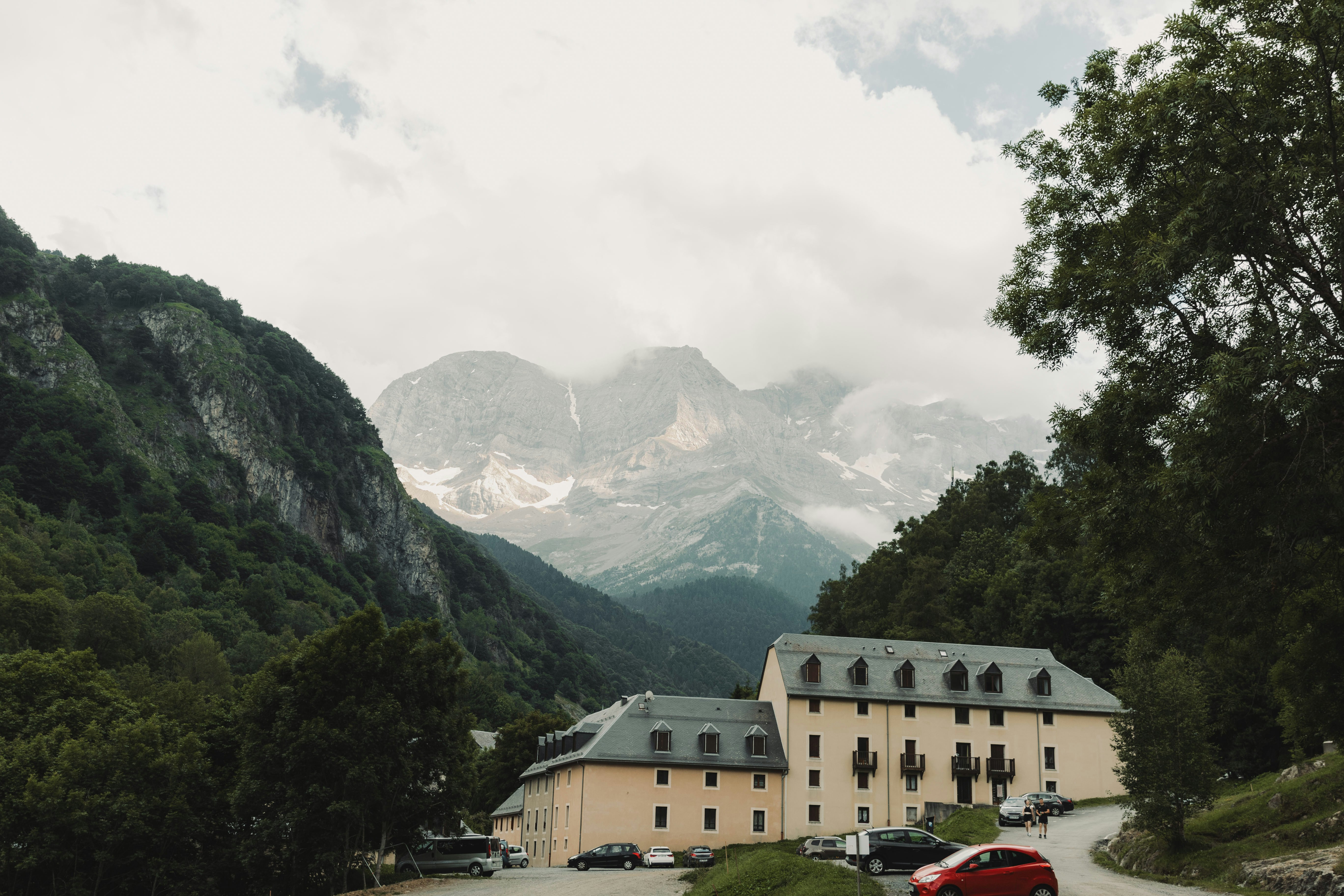 A red van parked in front of a large building photo – Free Gavarnie ...