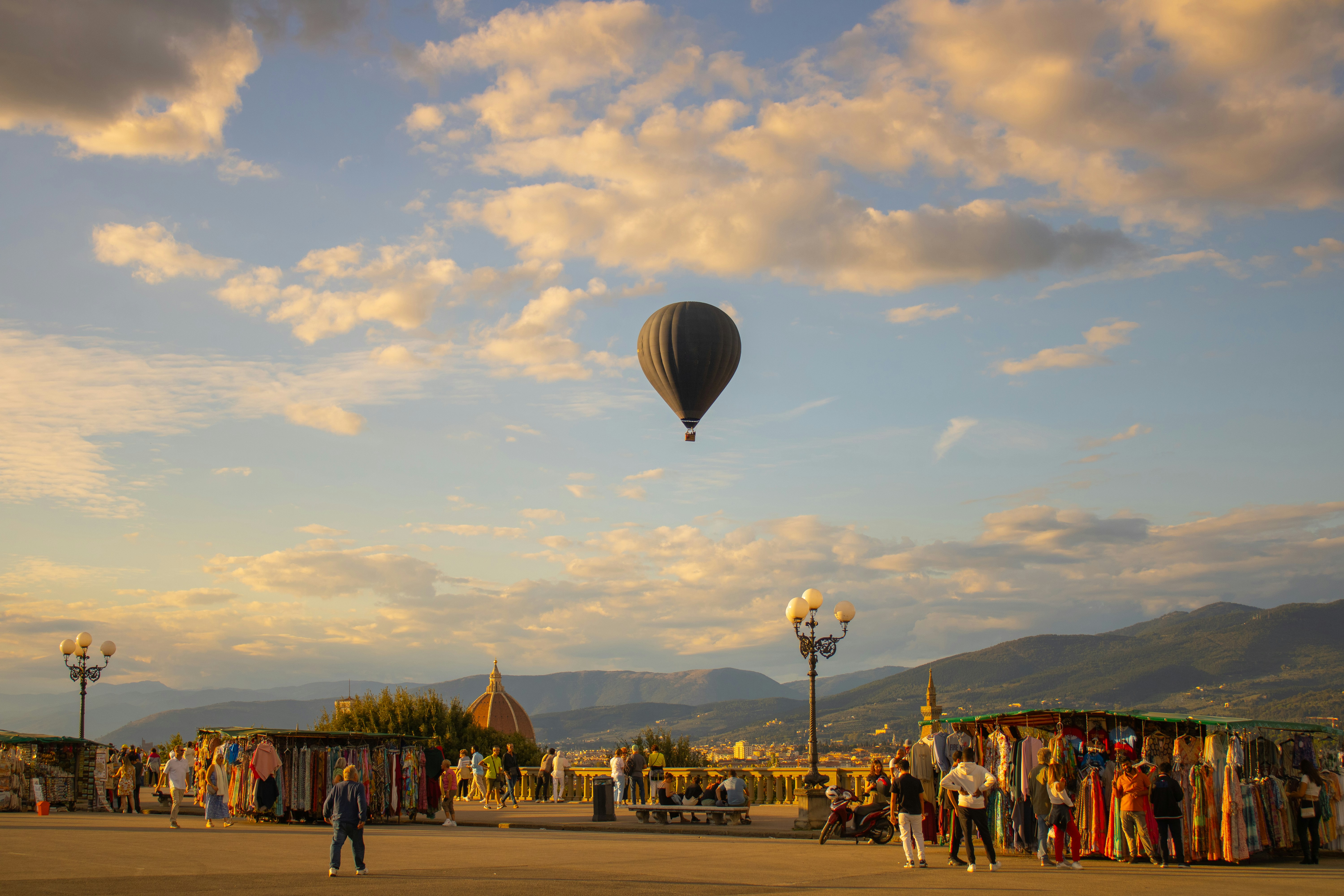 A hot air balloon flying over a crowd of people photo – Free Human ...