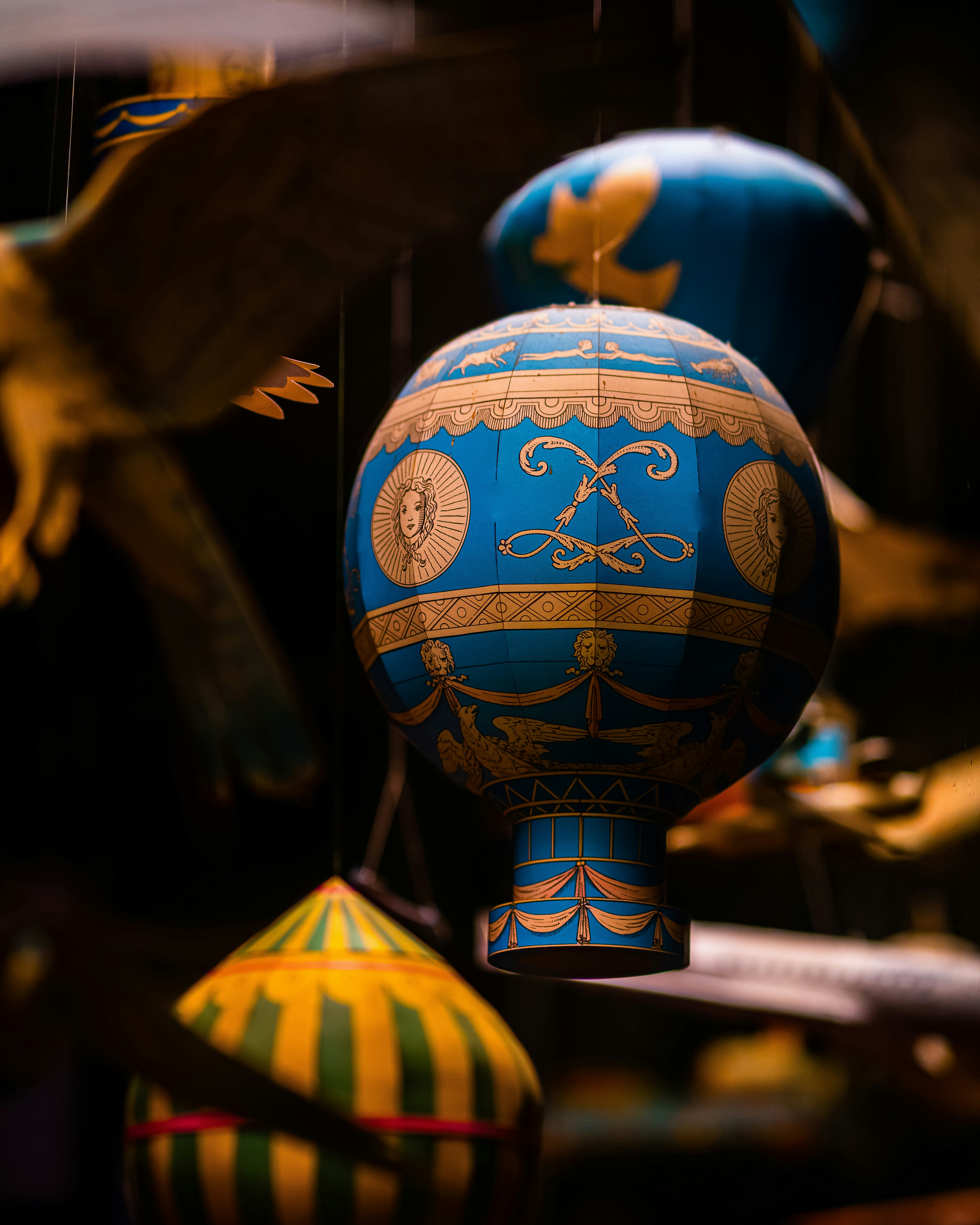 Cerulean Lanterns: Delicate Gold Motifs in a Dim Bazaar