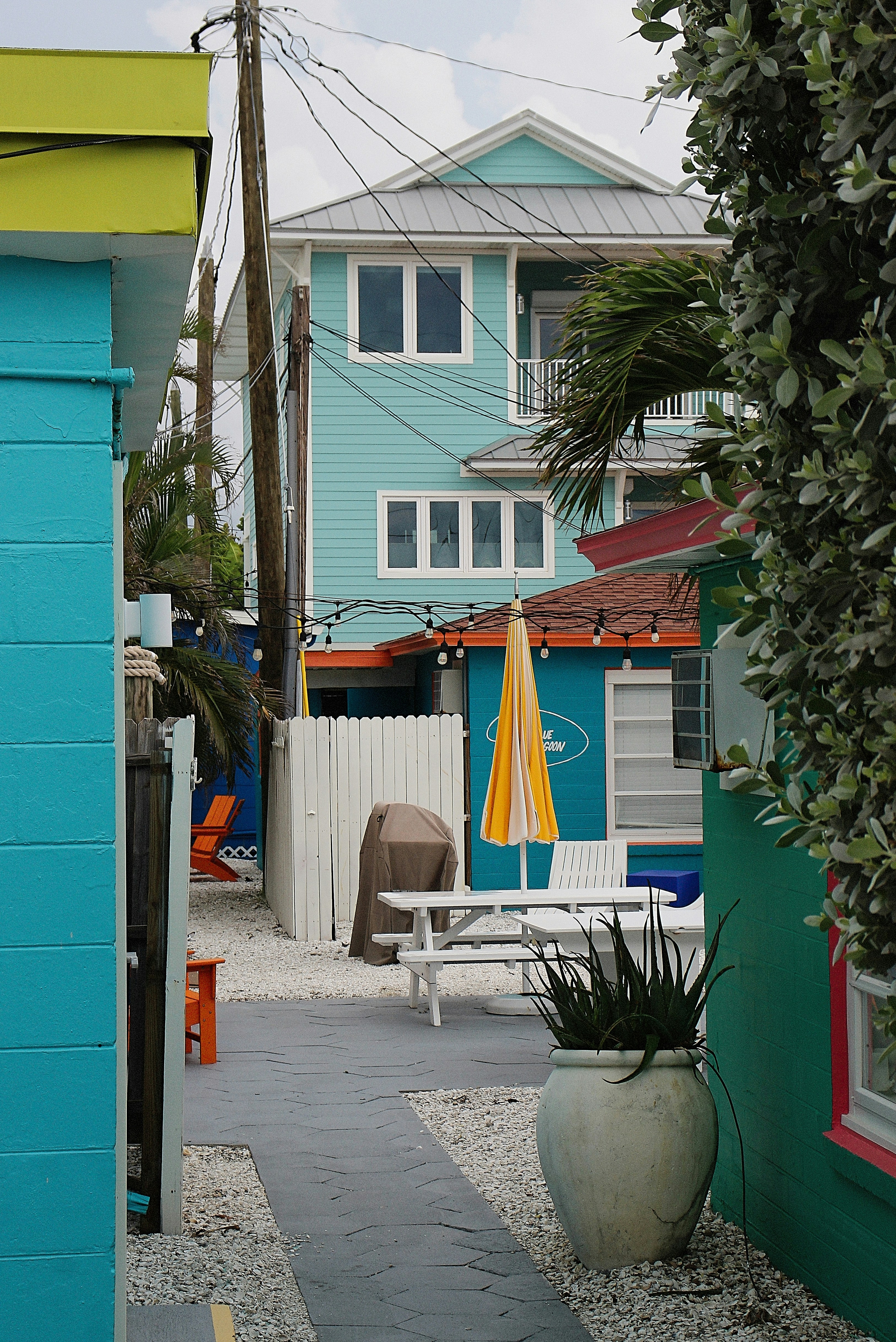 Sunlit Turquoise Terrace: An Alleyway to a Caribbean Courtyard