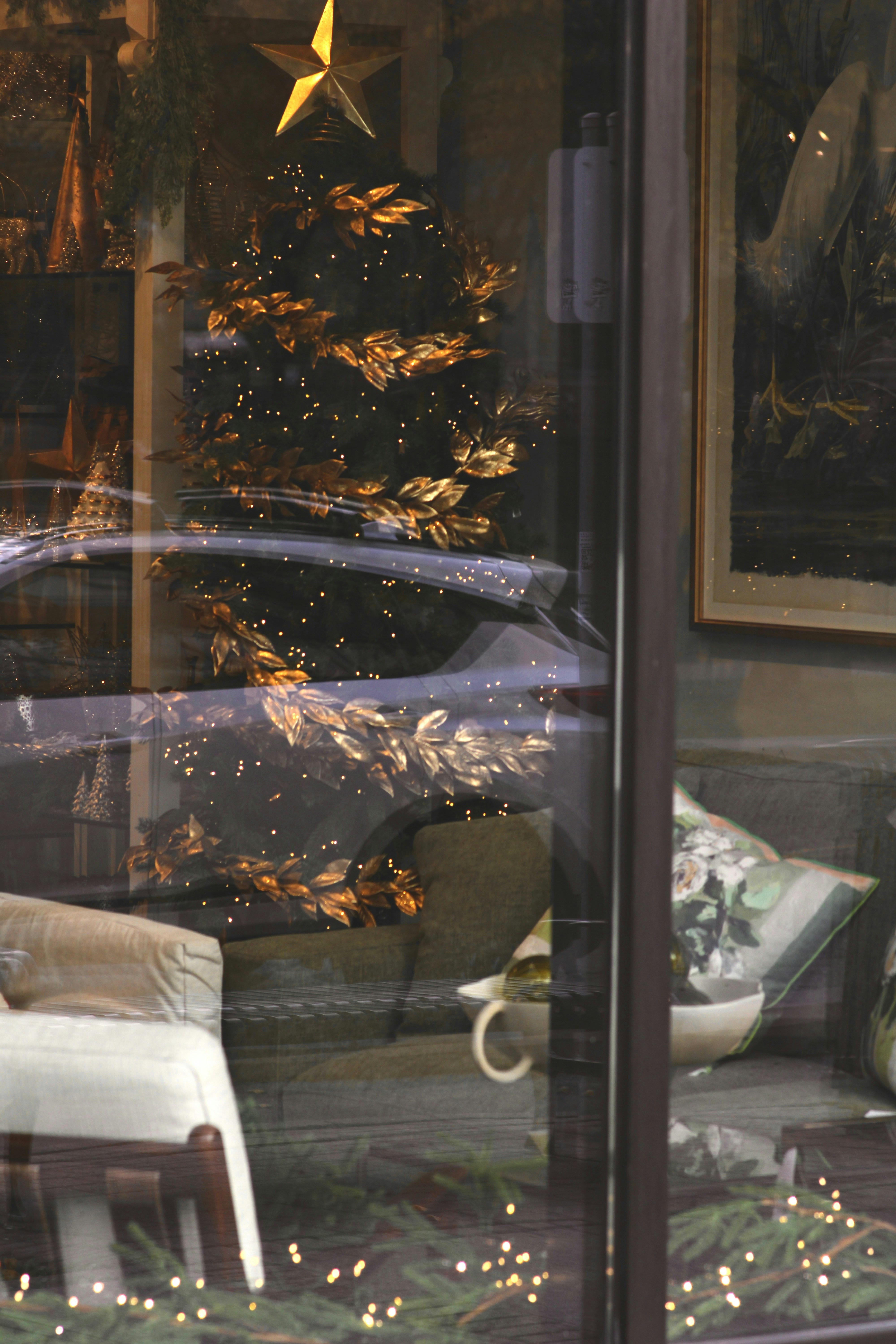 A christmas tree is seen through a window photo – Free Christmas Image ...