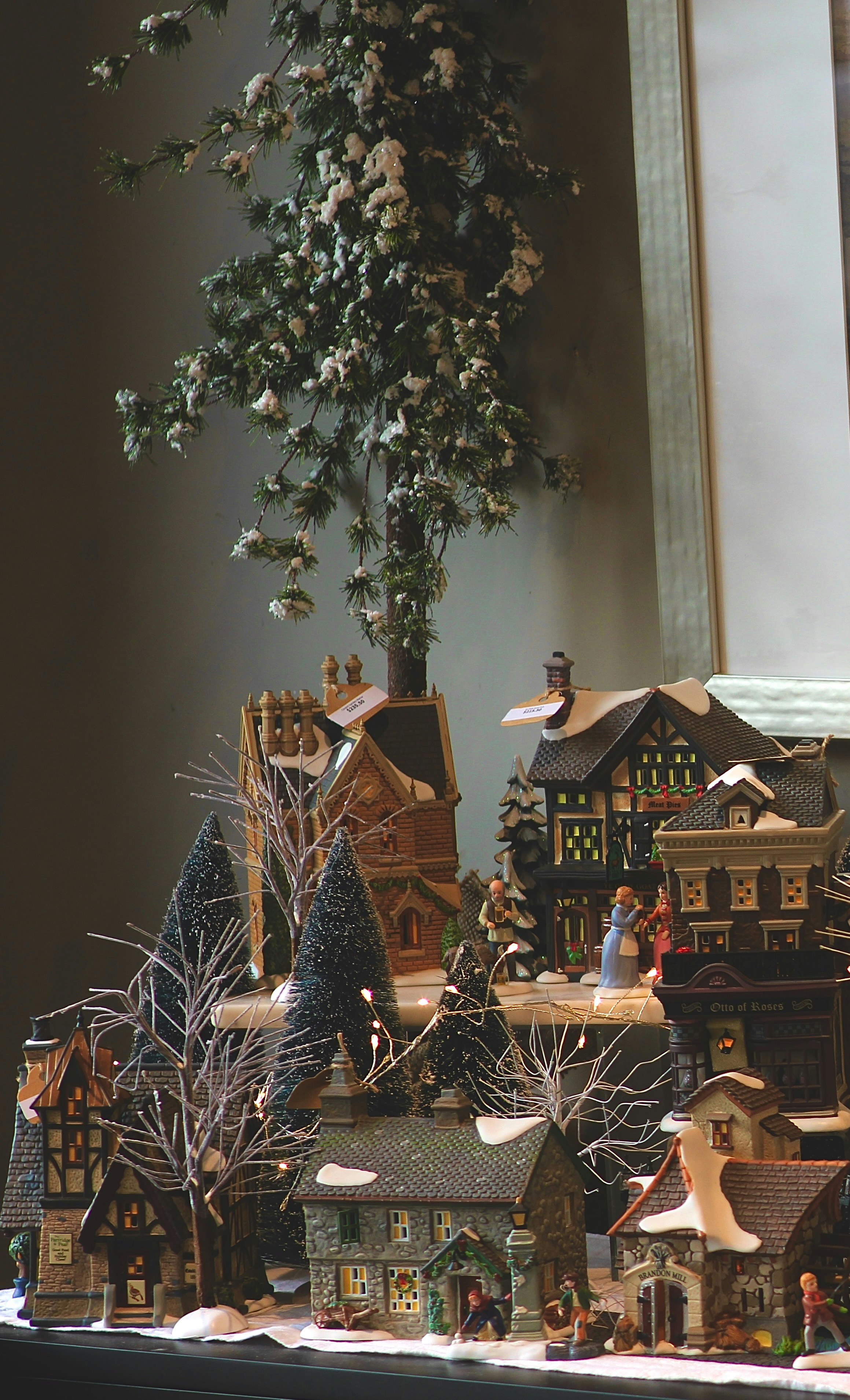 Snow-Capped Miniature Village Basks in Window Light