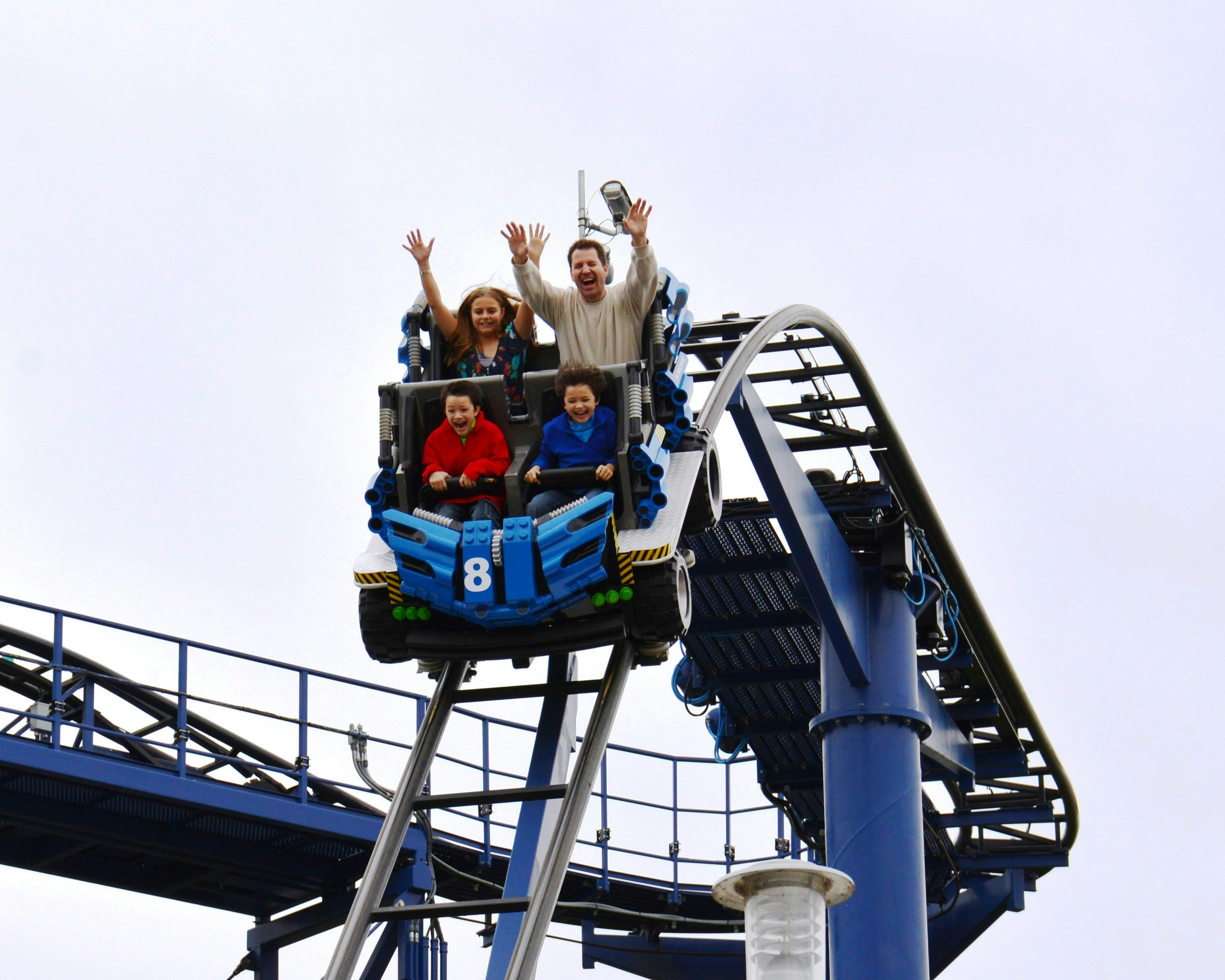 A group of people riding a roller coaster photo – Free Adult Image on ...