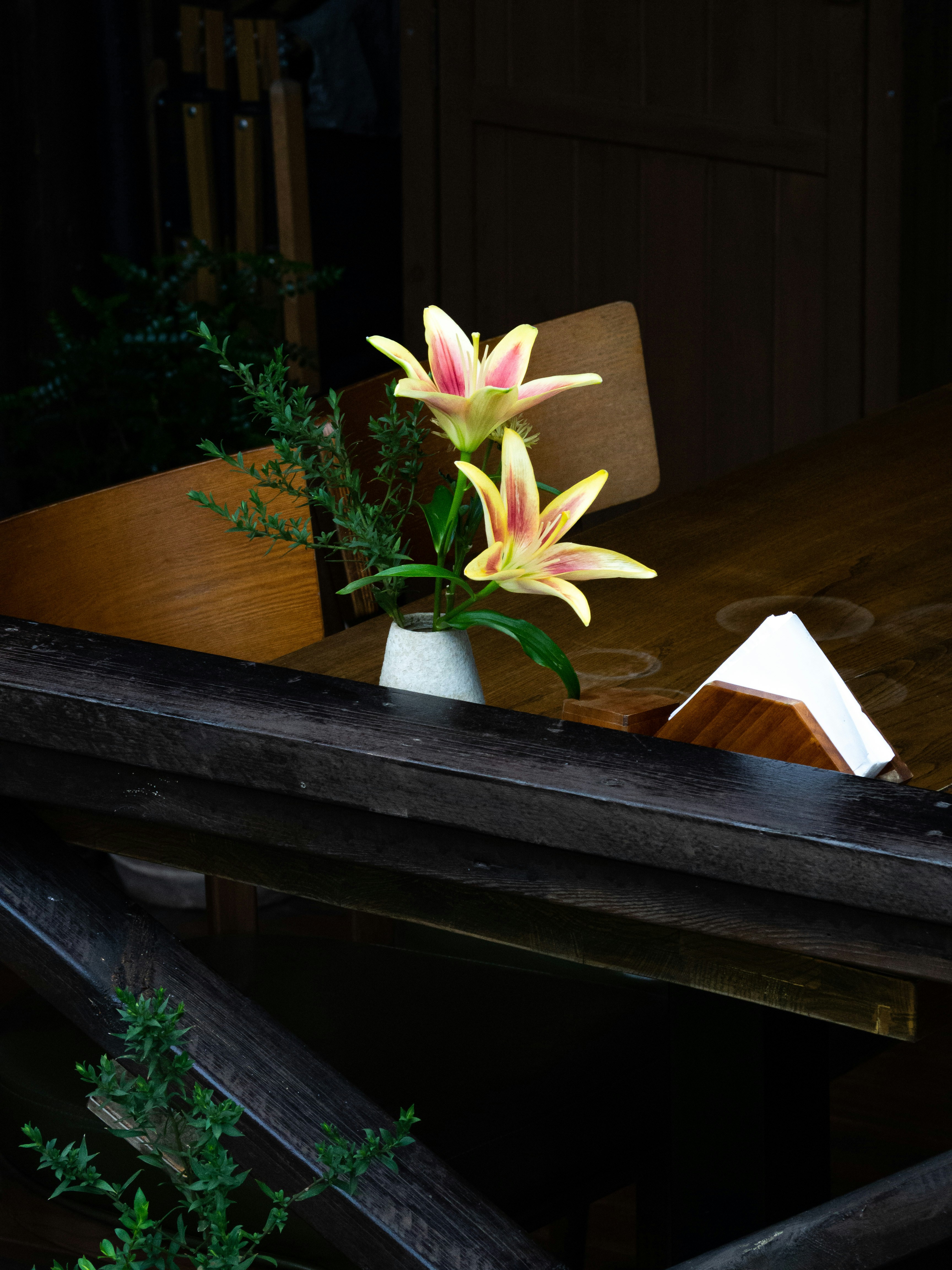 Lilies in a Dim Rustic Dining Nook