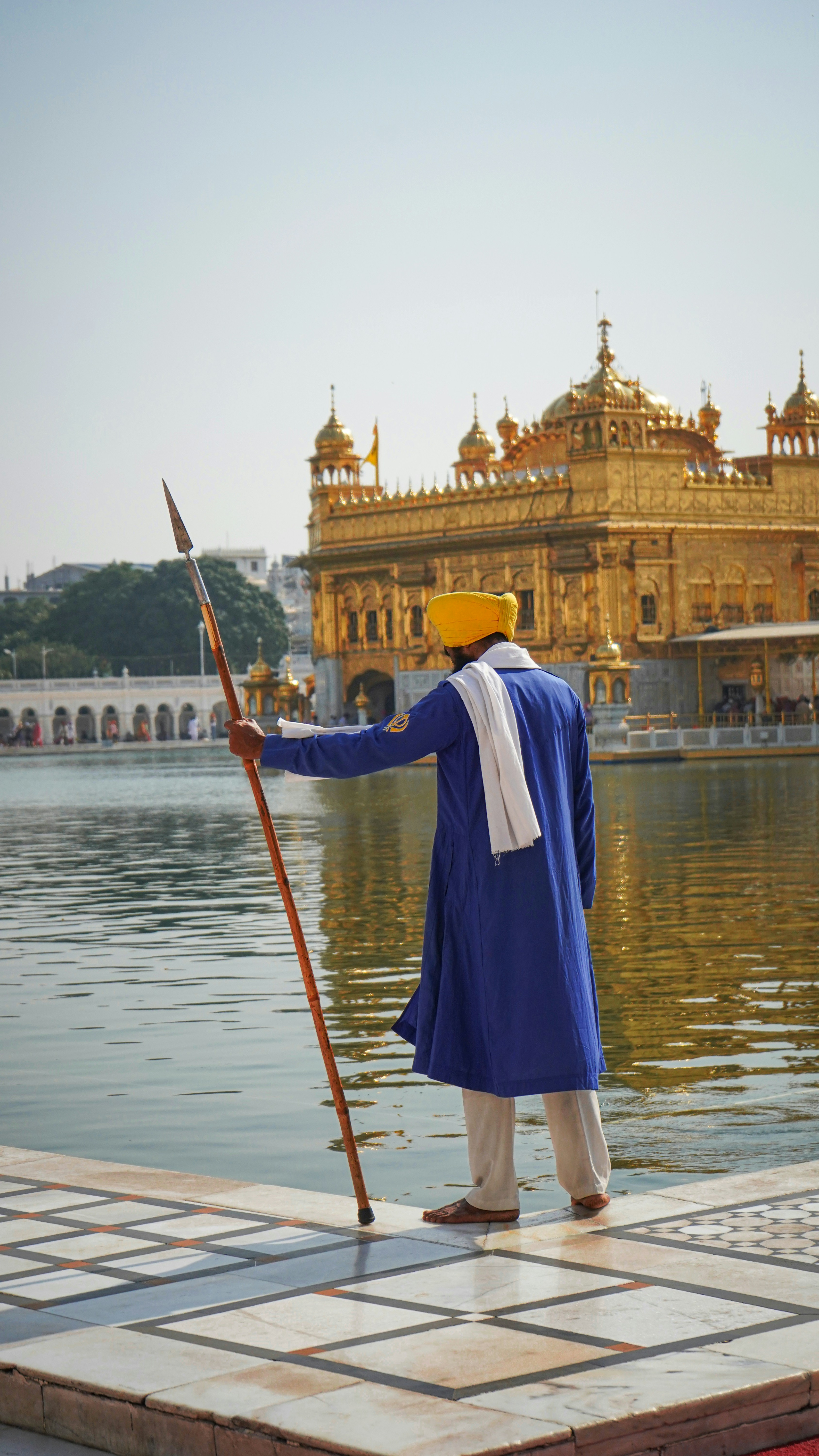 Blue Robe by the Golden Temple: A solitary pilgrim and the gilded backdrop