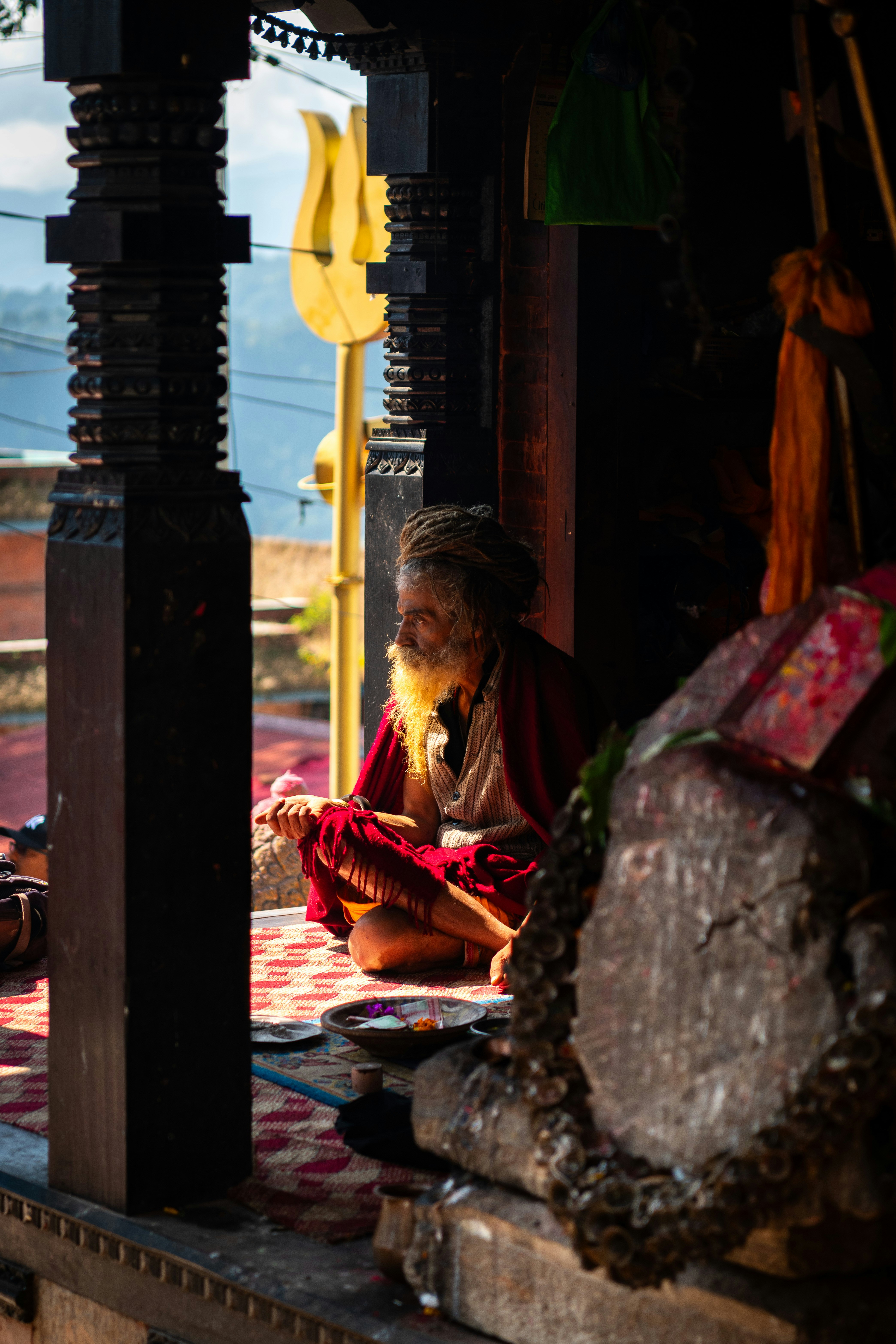 A man sitting on a bench in a temple photo – Free Nepal Image on Unsplash