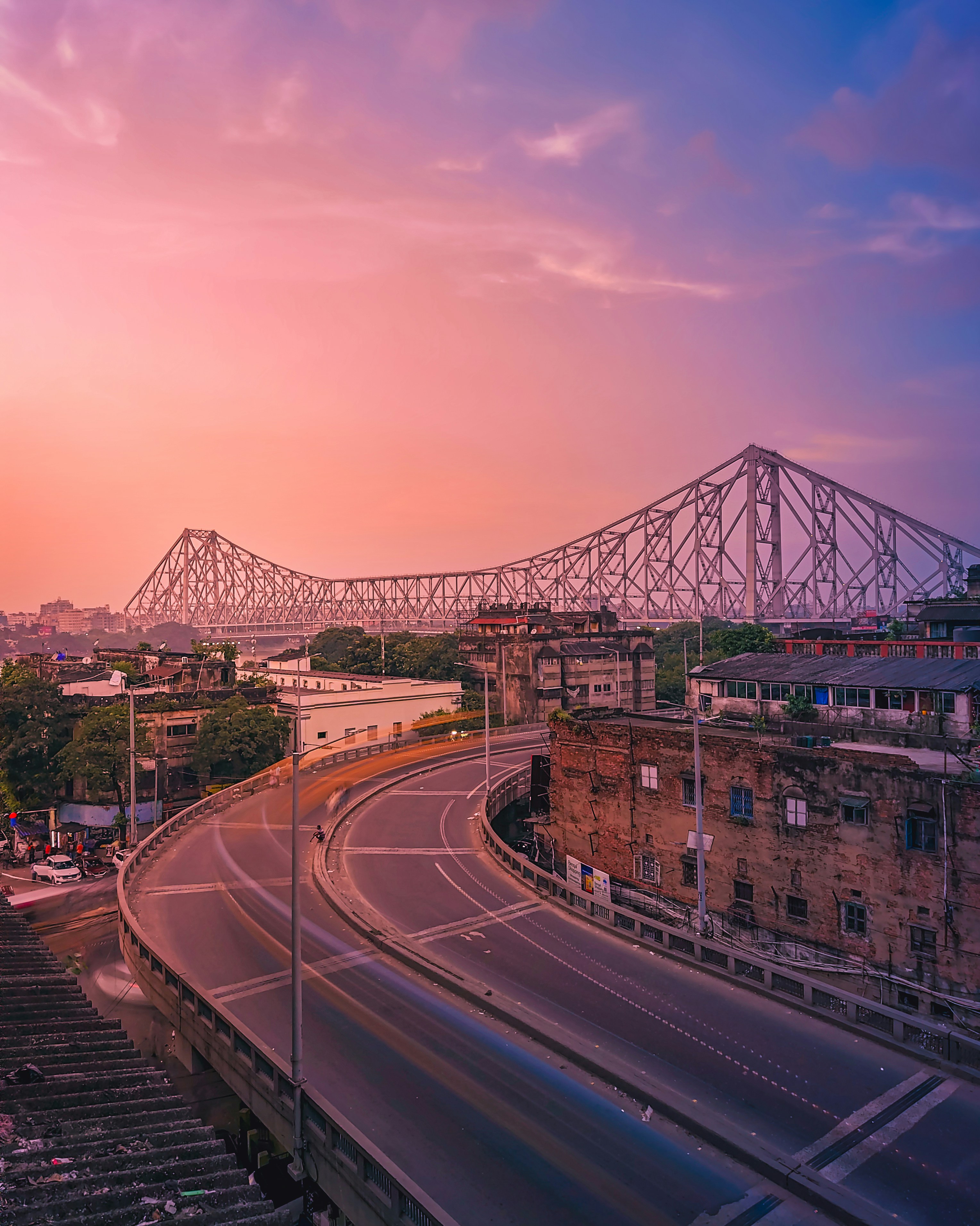 Sunset Over the Bridge: A City Roadway Framed by Steel and Sky