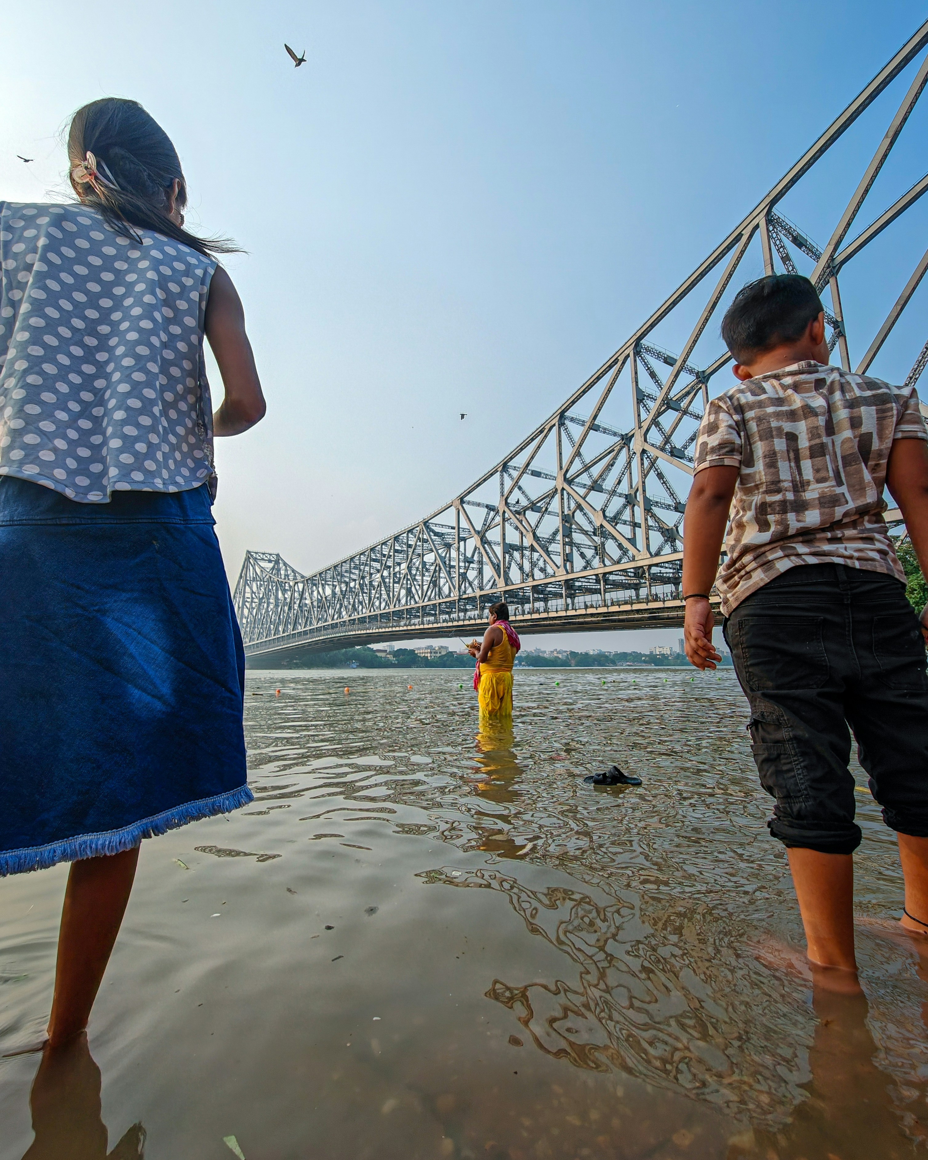 River Crossing Spotlight: Children in the Shallow Waters by the Bridge