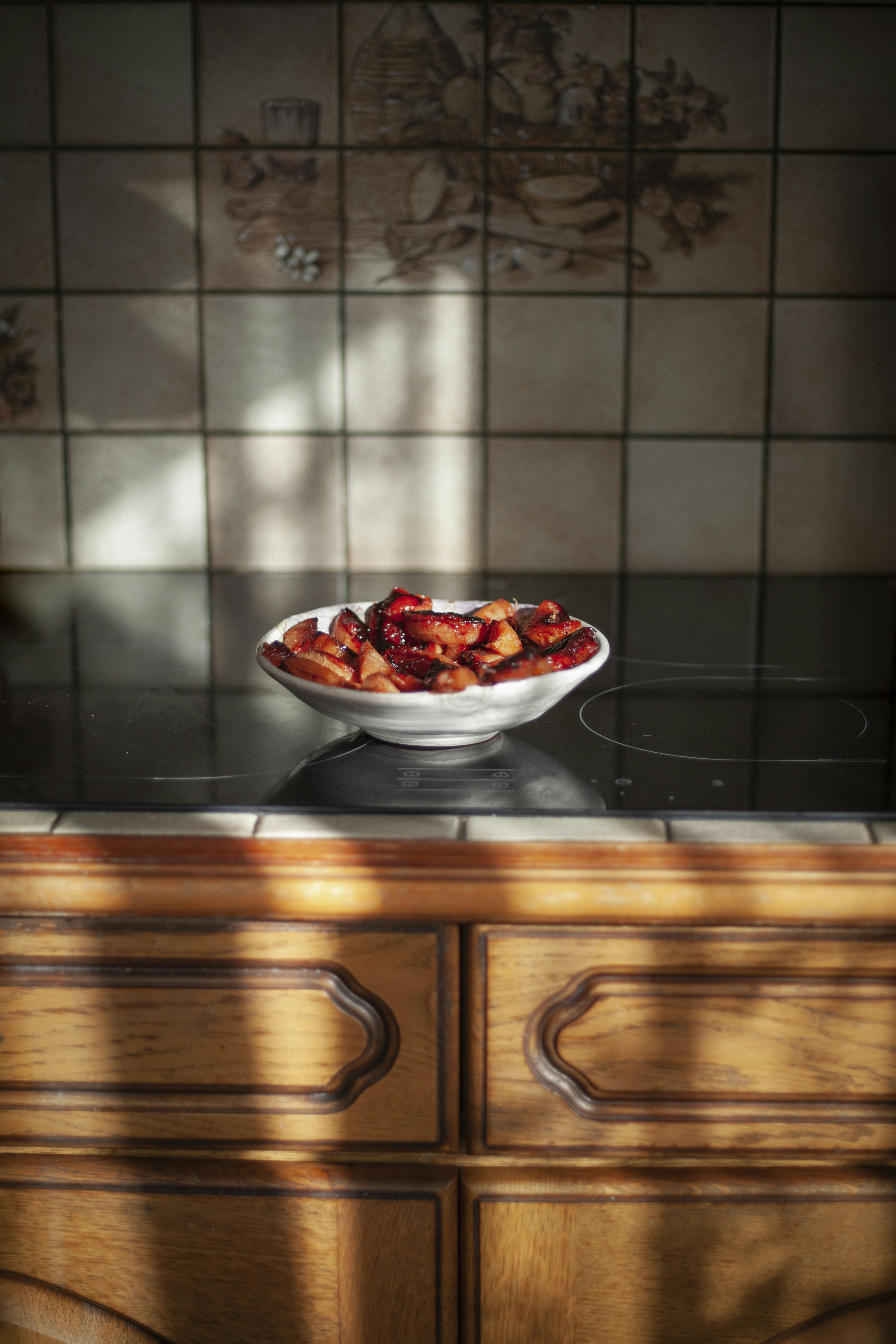 Sunlit Fruit Bowl on a Vintage Kitchen Stovetop