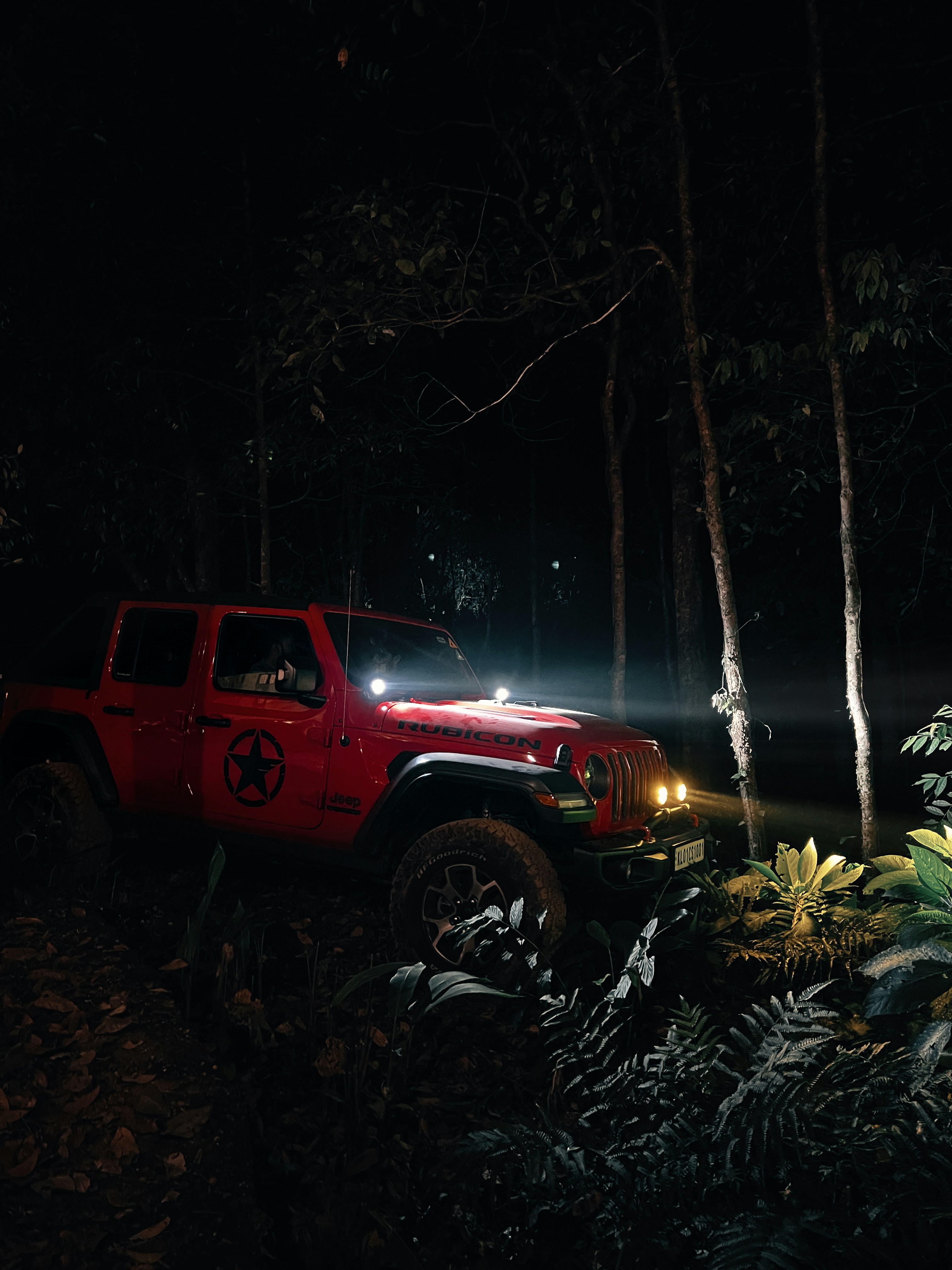 A red jeep parked in the woods at night photo – Free Car Image on Unsplash