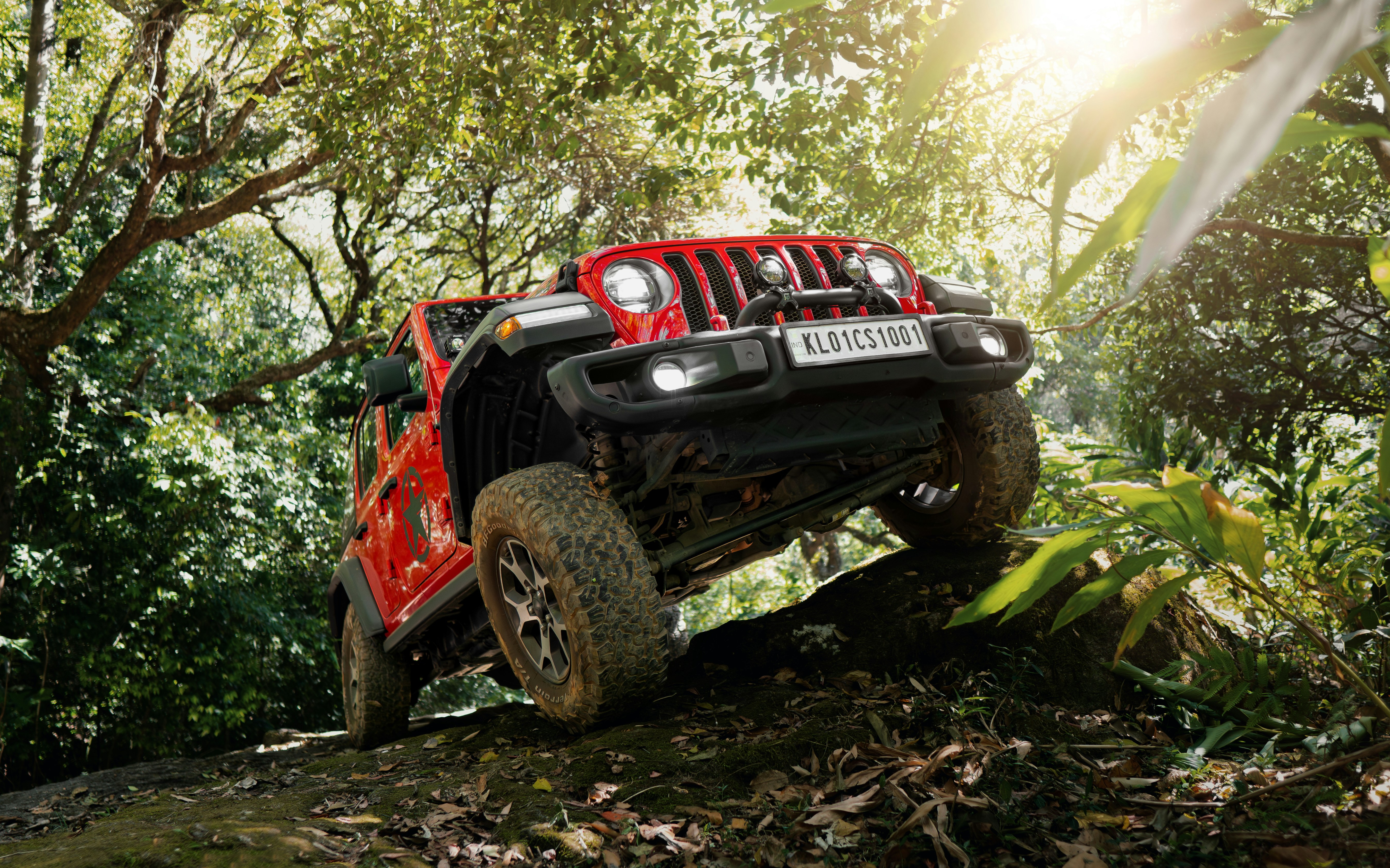 A red jeep driving through a forest on a trail photo – Free Car Image ...