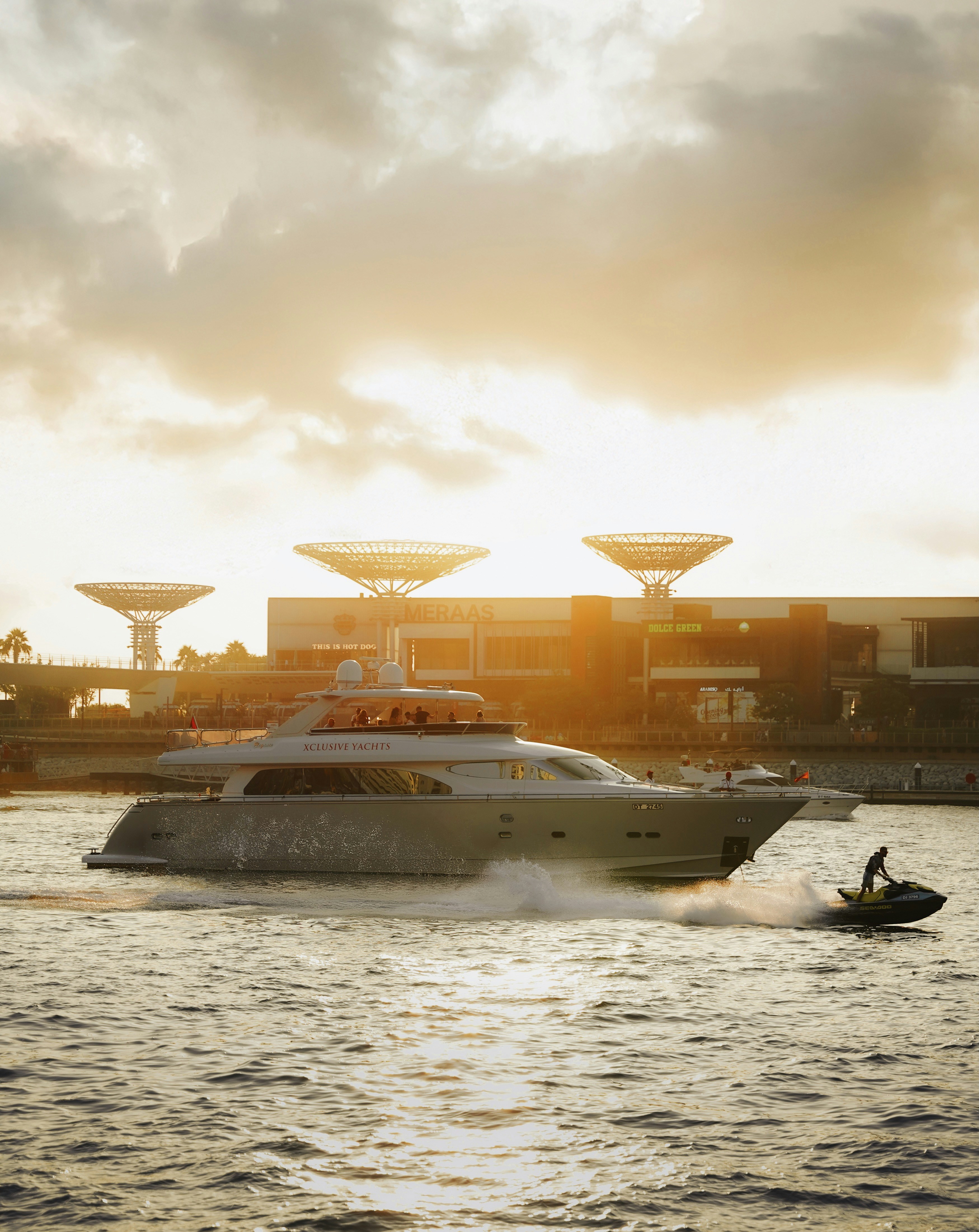 A white boat in a body of water photo – Free Dubai marina Image on Unsplash