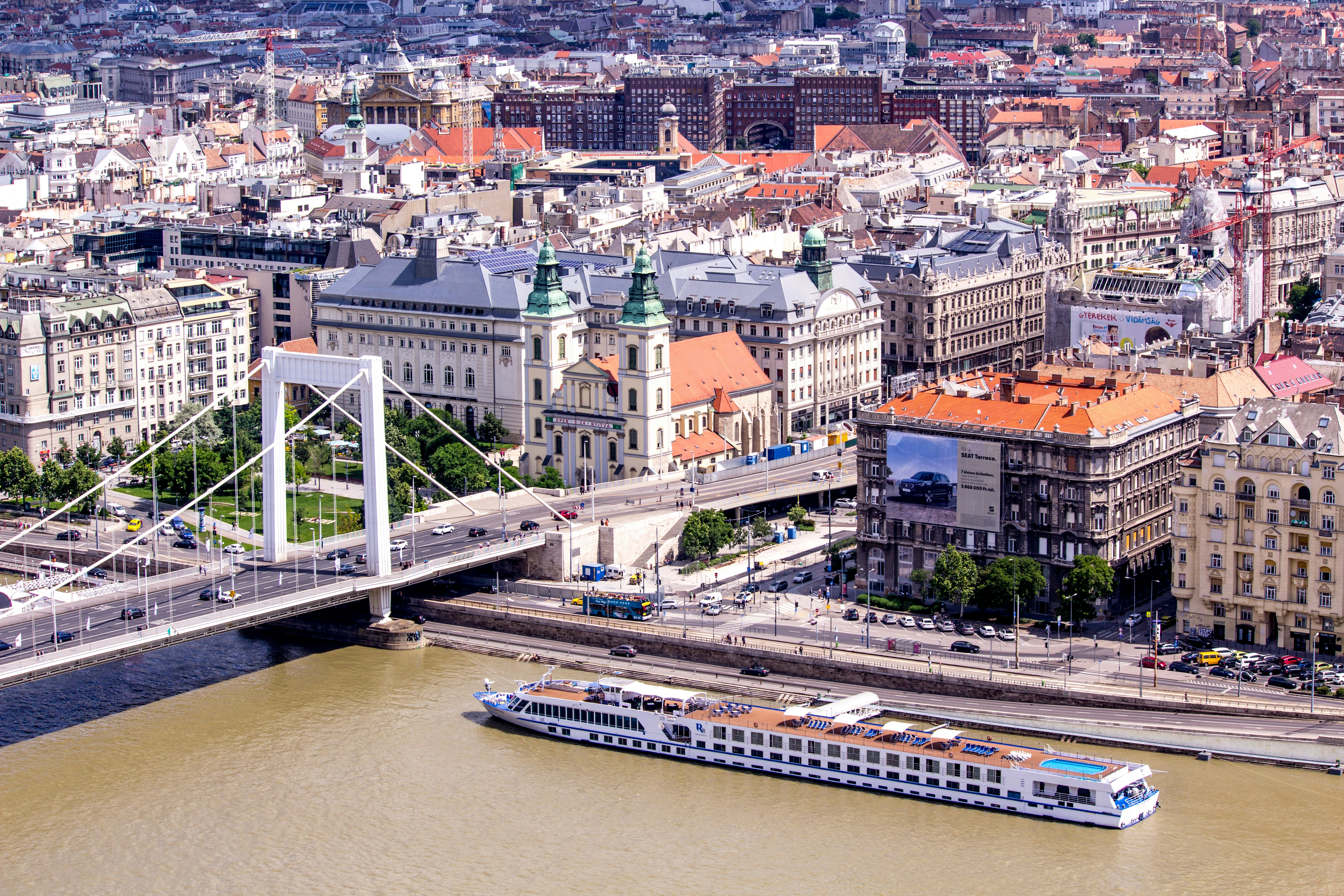 A boat is on the water near a bridge