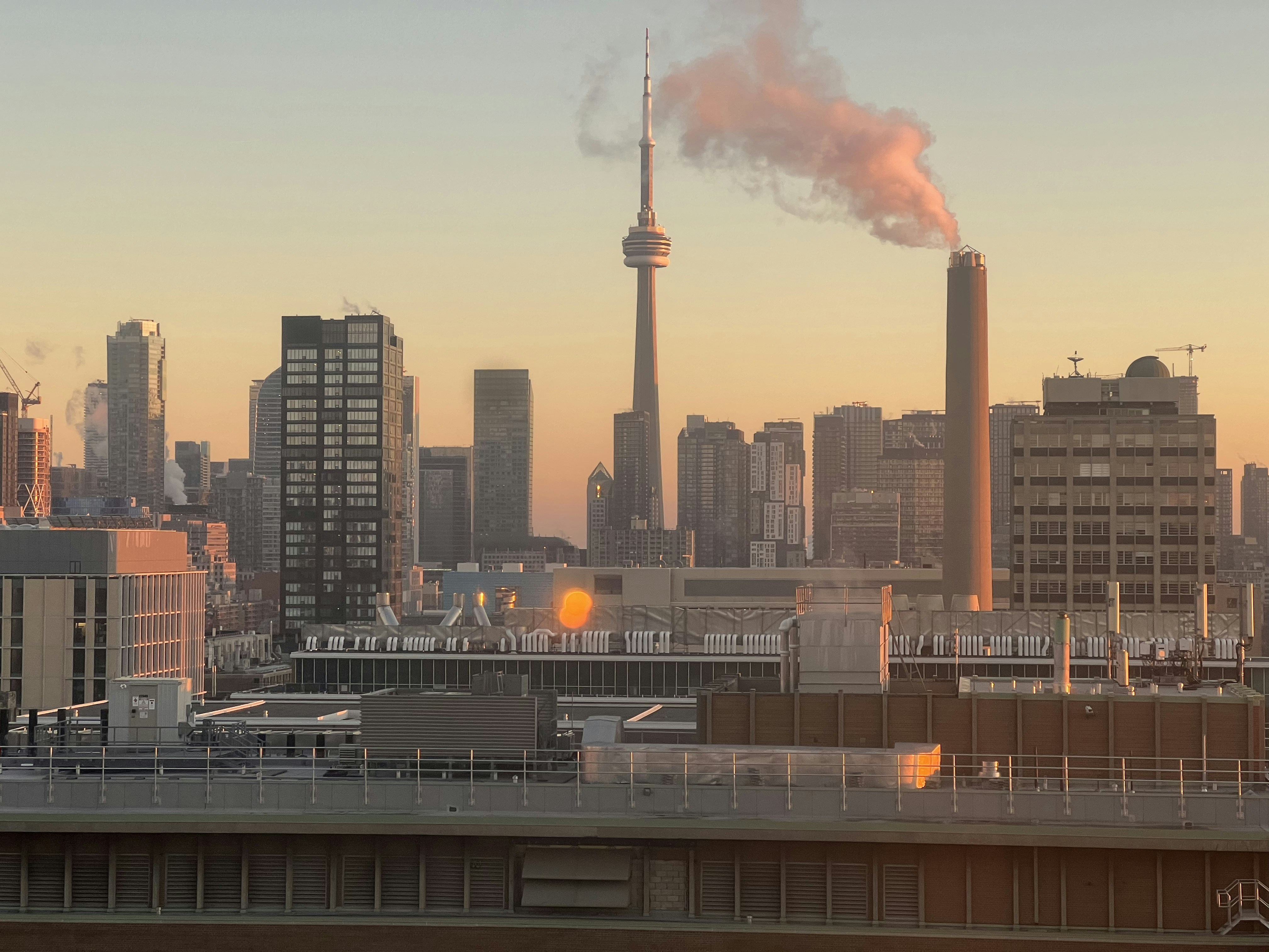 Crimson Hour Over Toronto: CN Tower Framed by Smoke and Sunset