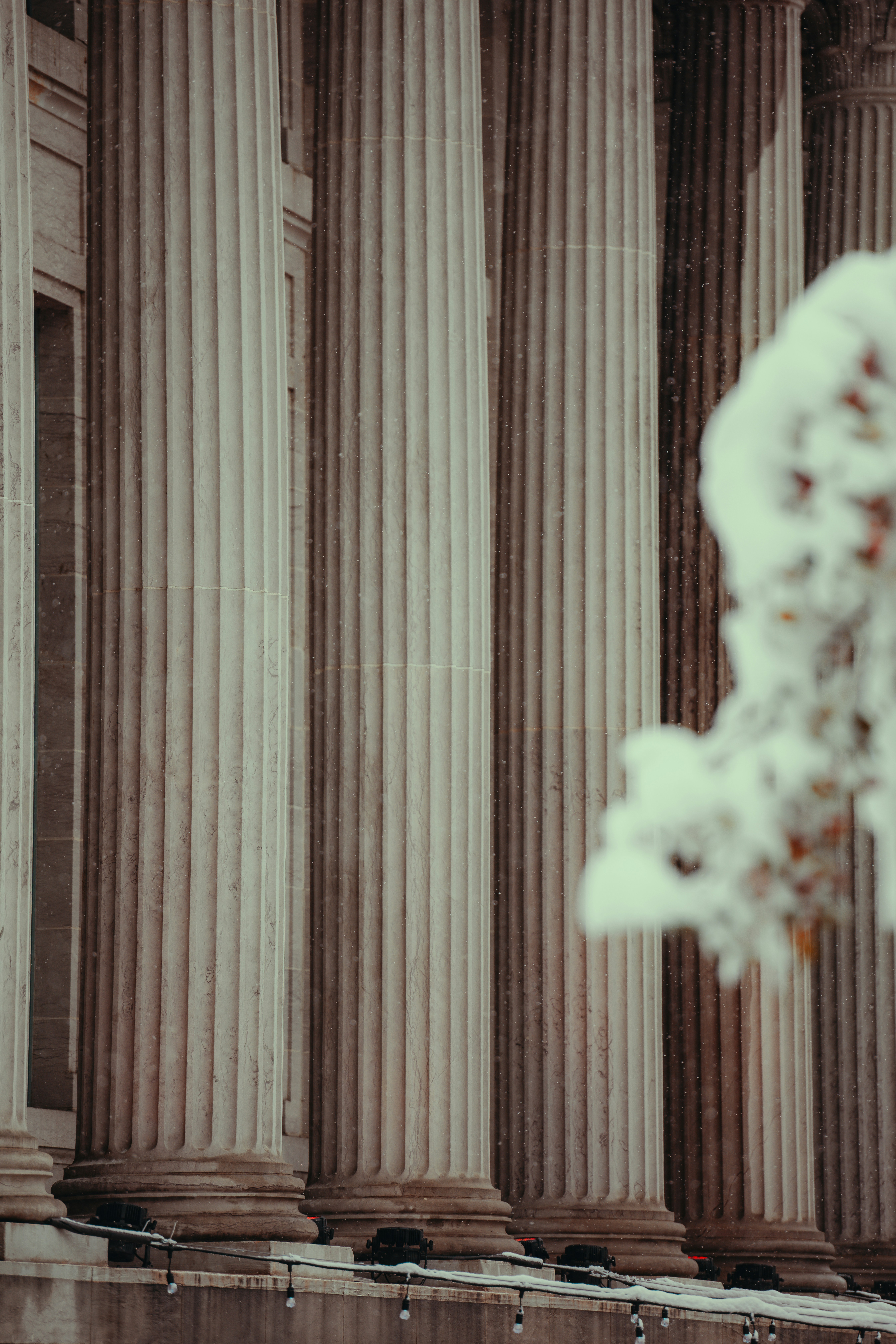 A building with columns and snow on the ground photo – Free Denver ...