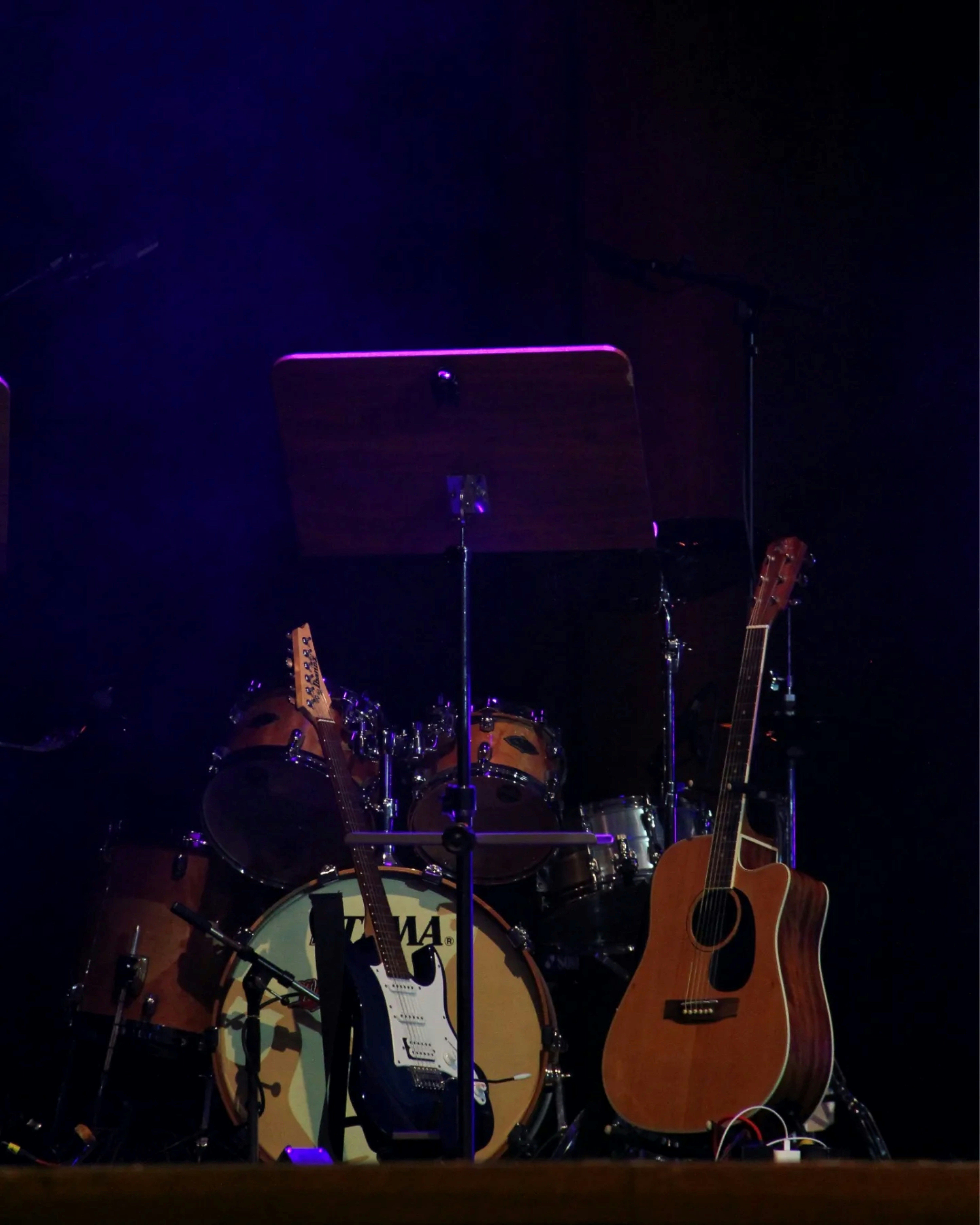 A group of guitars sitting on top of a stage photo – Free Guitar Image ...