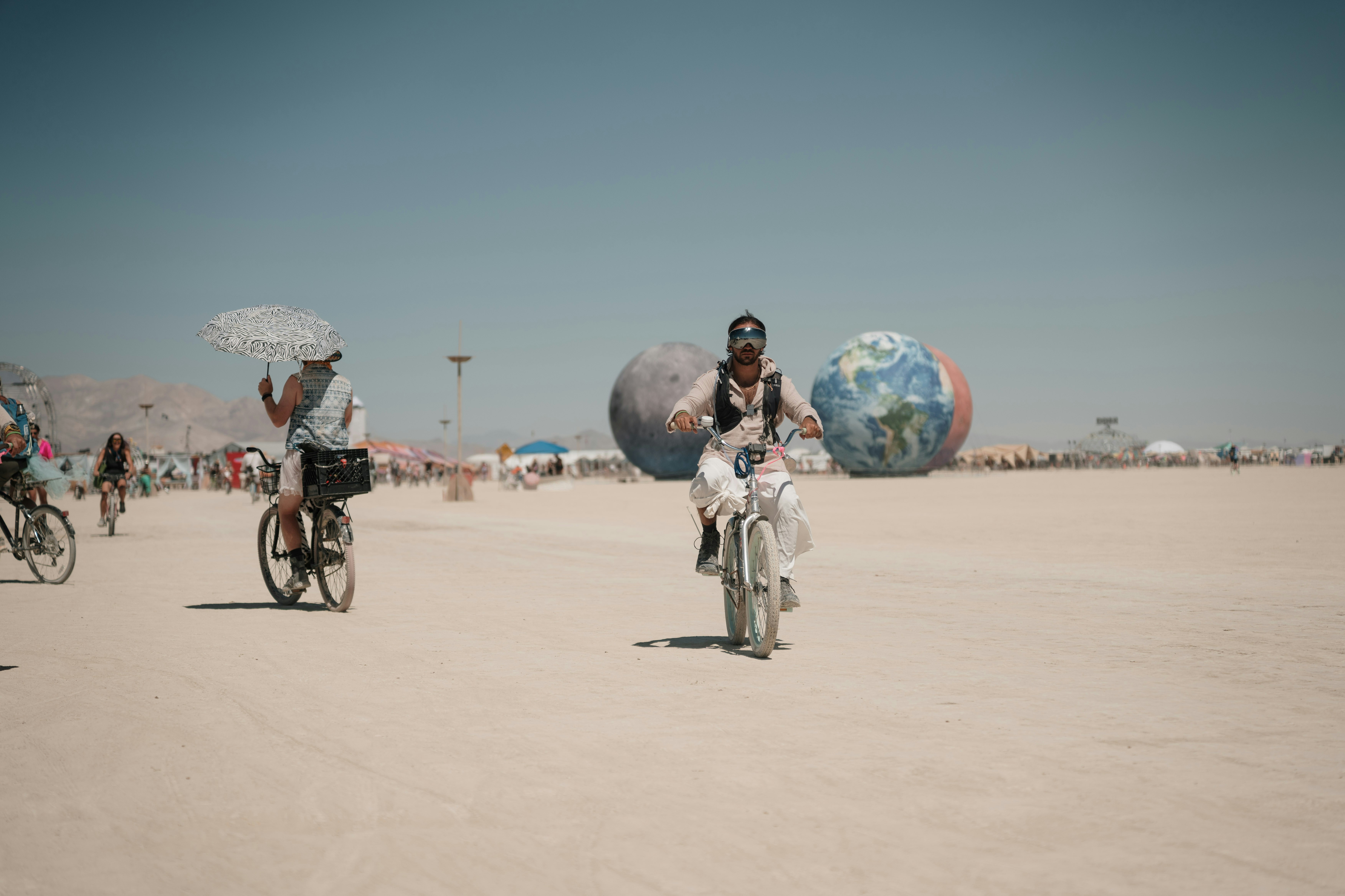 Burning Man Festival - in Nevada Black Rock City Couple on the background with Art Car in a Desert. Photographer Anton Mislawsky
