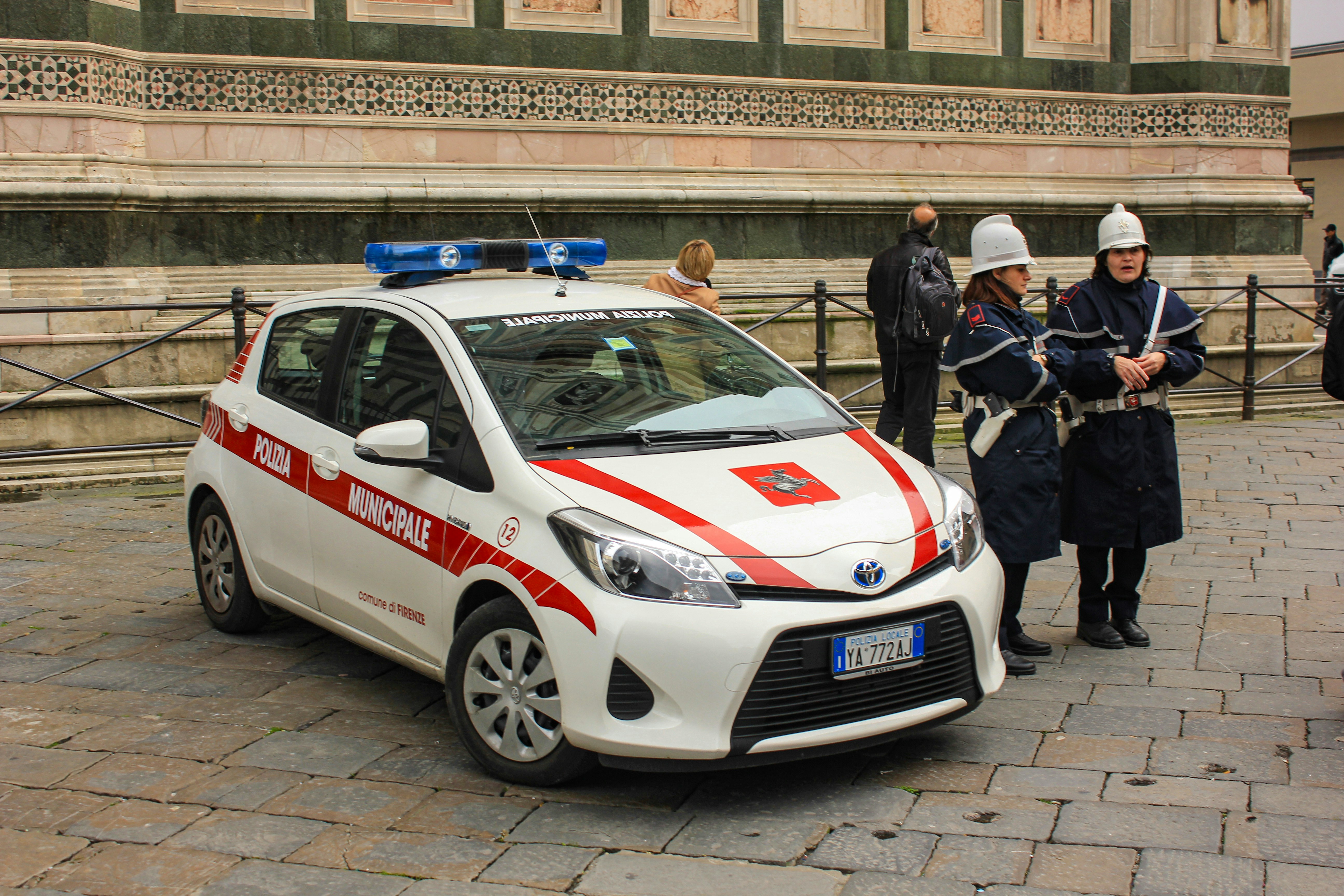 A police car parked in front of a building photo – Free Car Image on ...