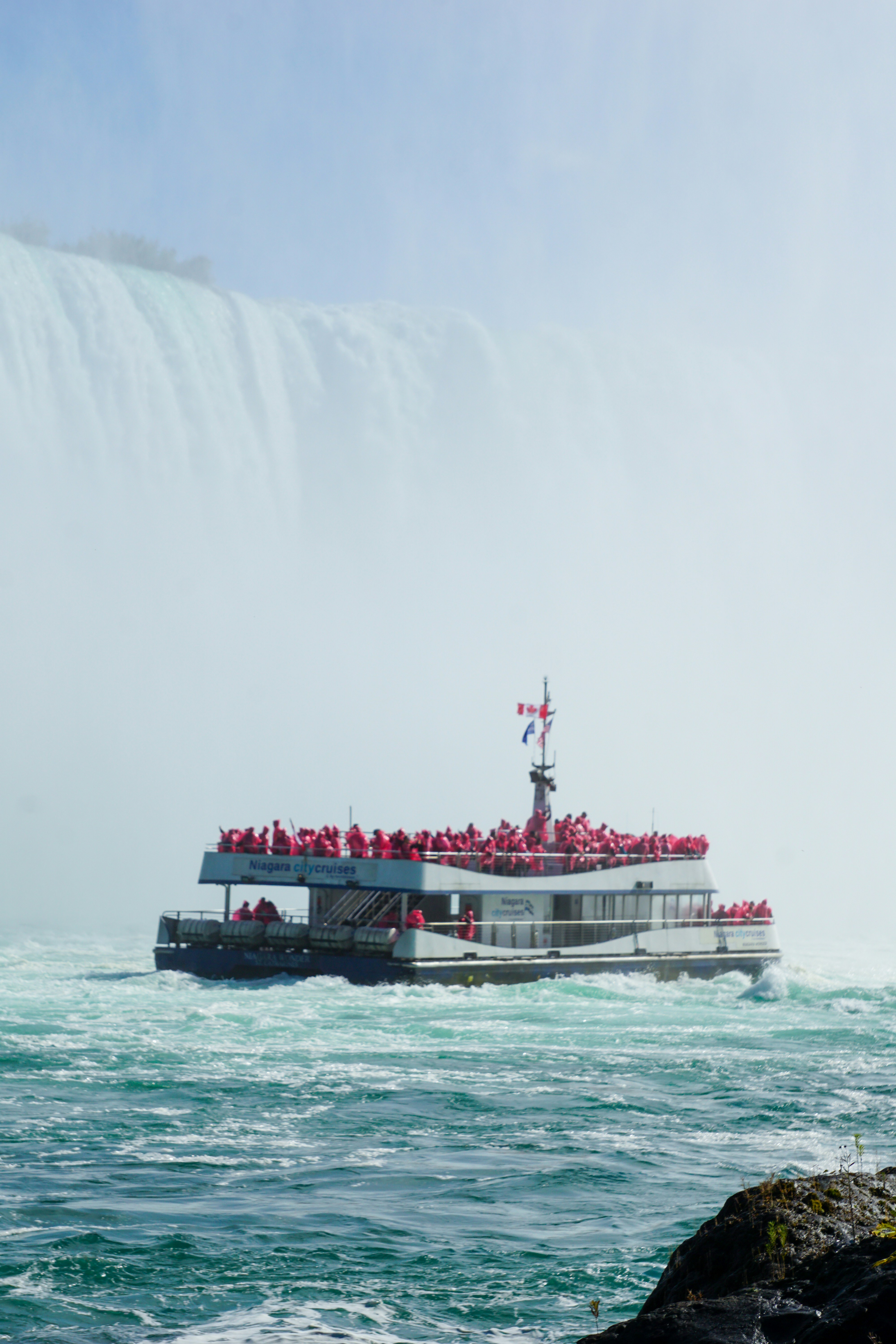 Crimson Parade Aboard a Niagara Falls Tour Boat Beneath the Falls' Mist