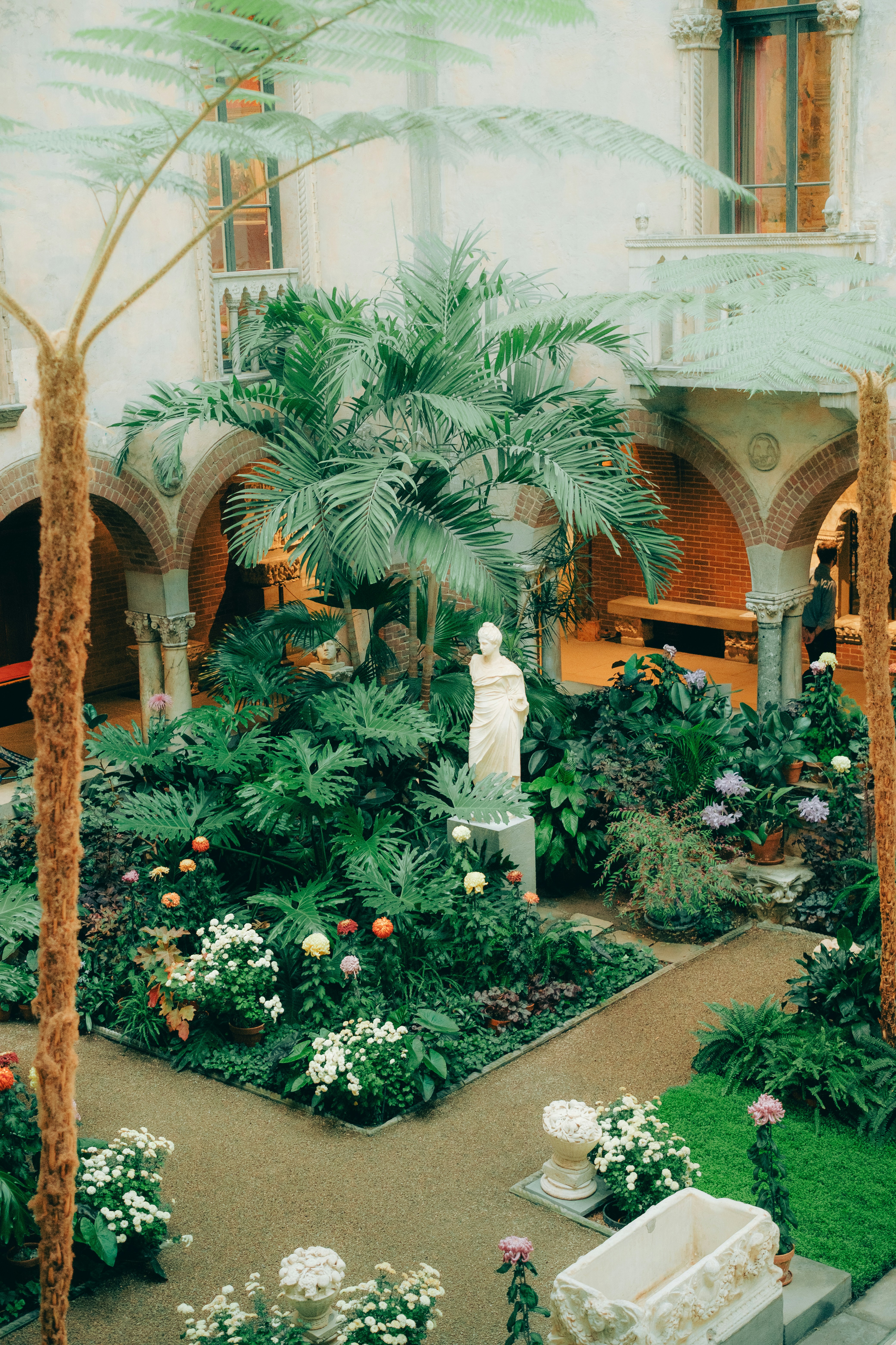 Temple Courtyard in Bloom: a marble statue Guarded by tropical greenery