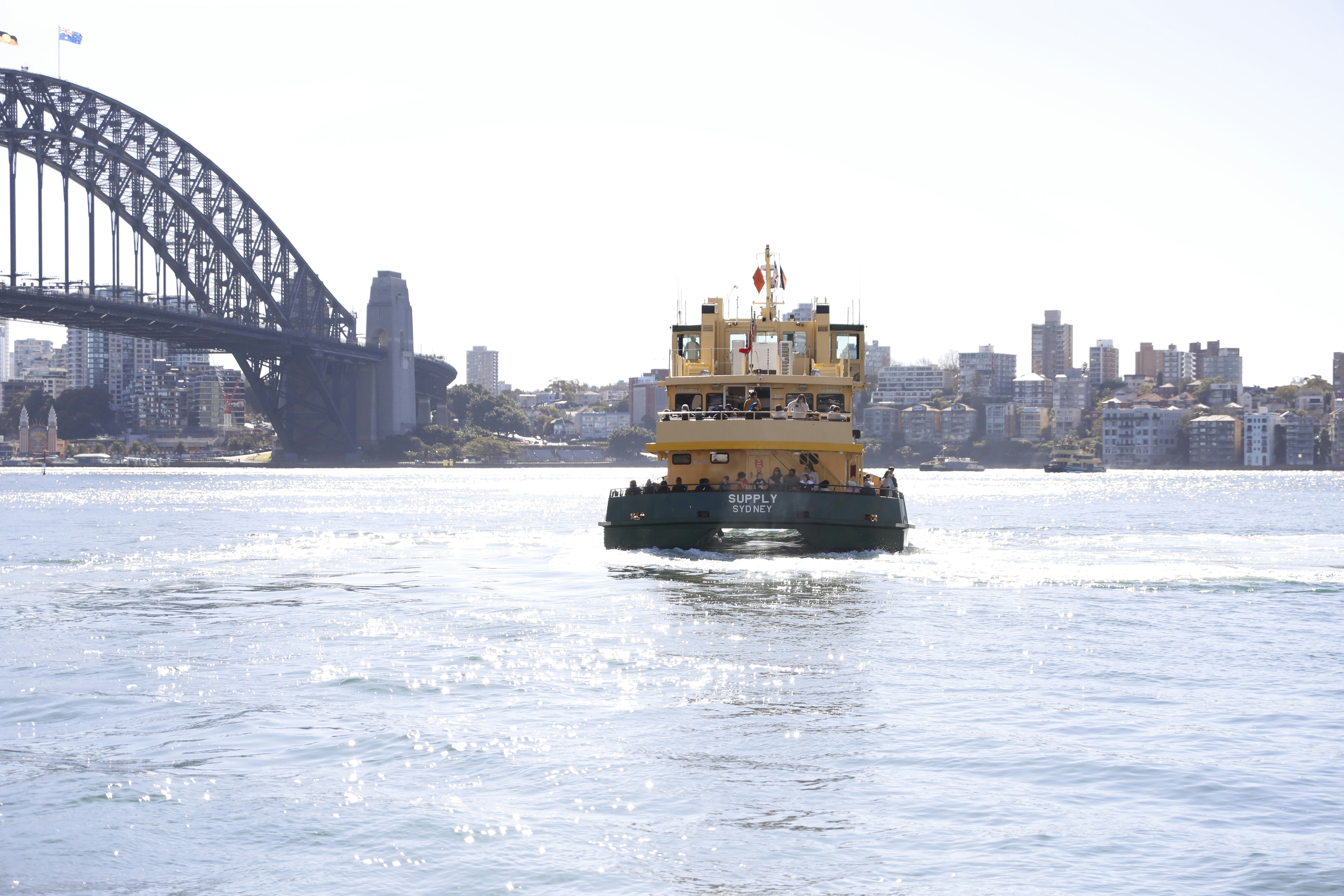 Yellow Tug Against Sydney's Harbor Skyline