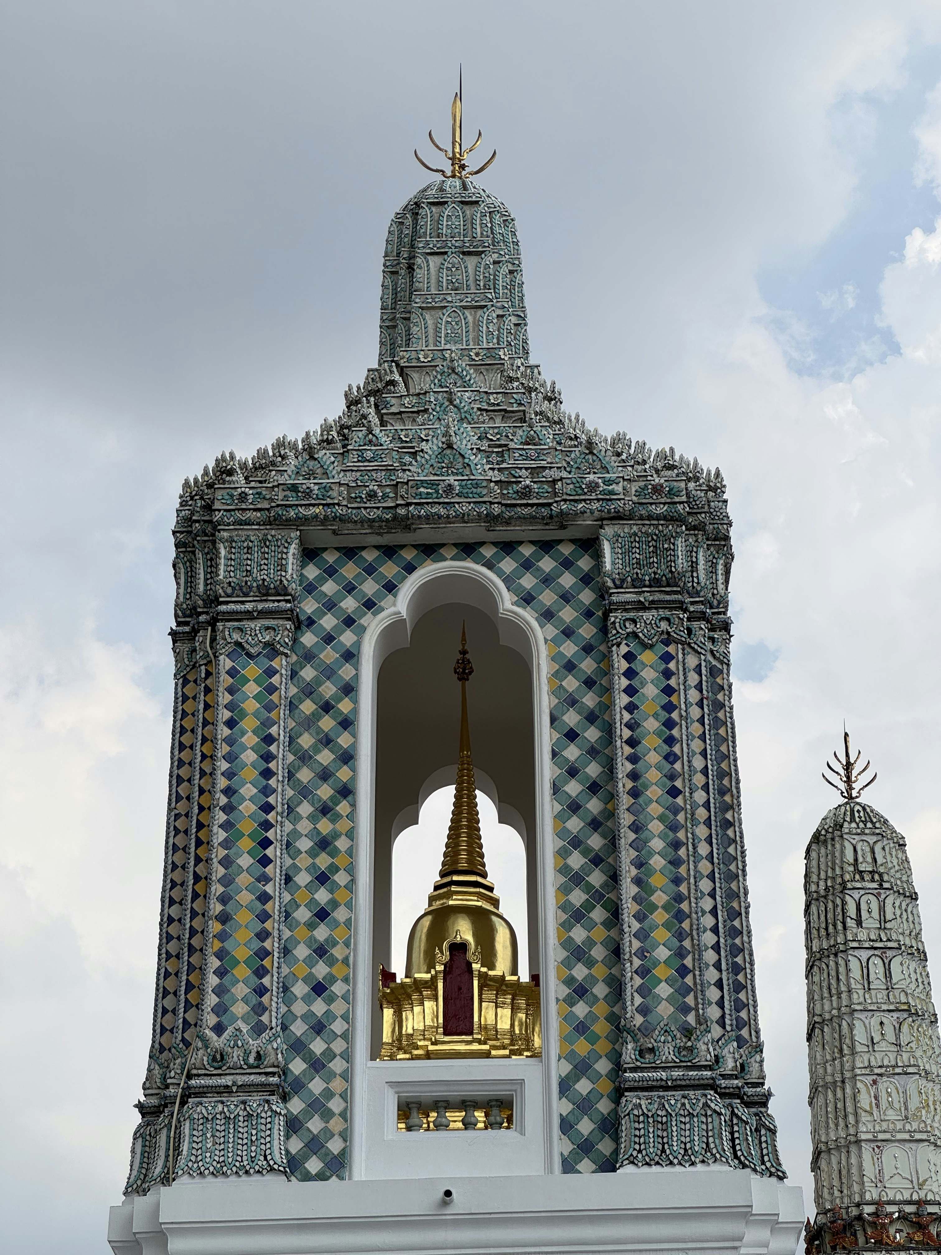 Azure Mosaic Gate Framing a Golden Stupa