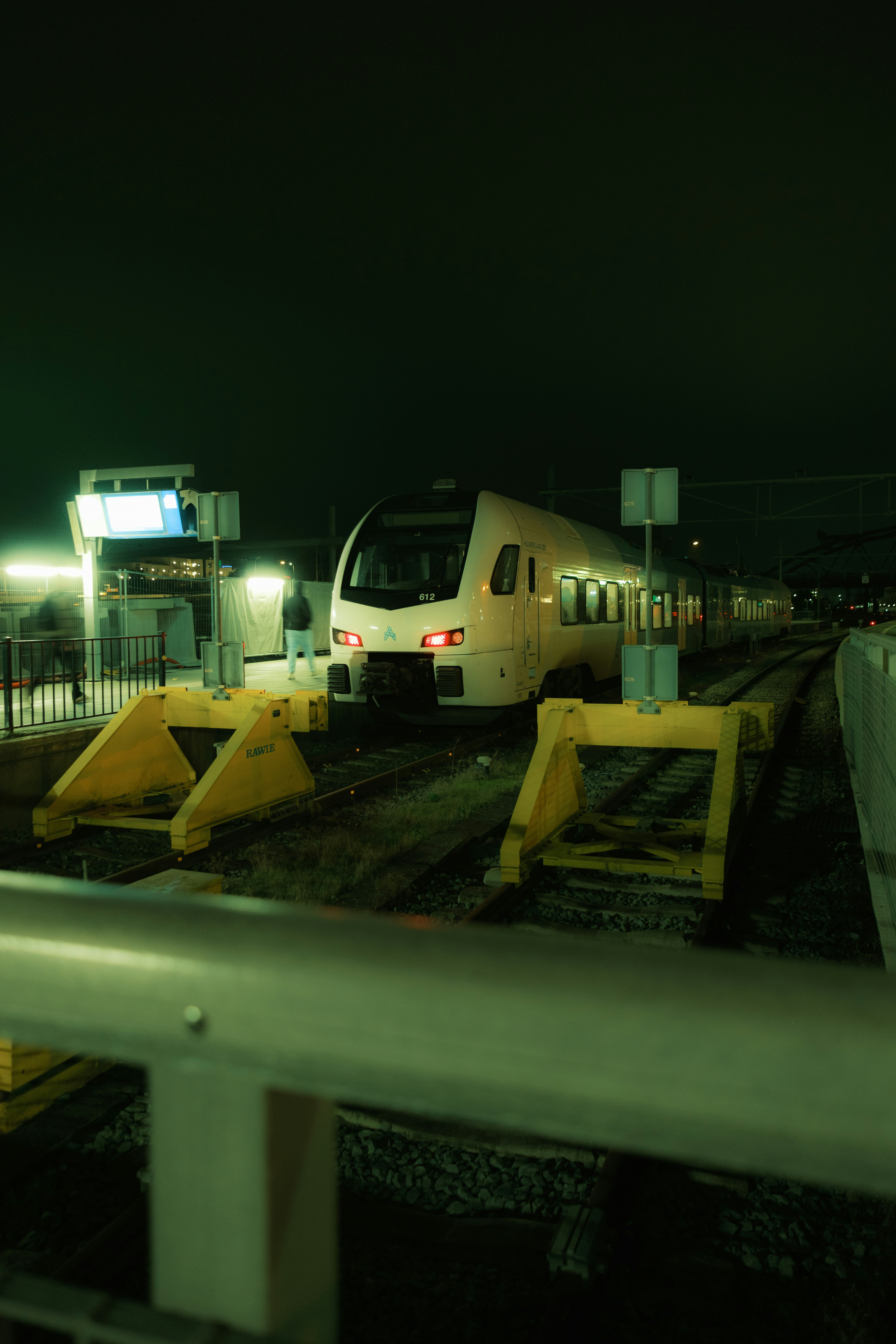 A train on a train track at night photo – Free Street photography Image ...