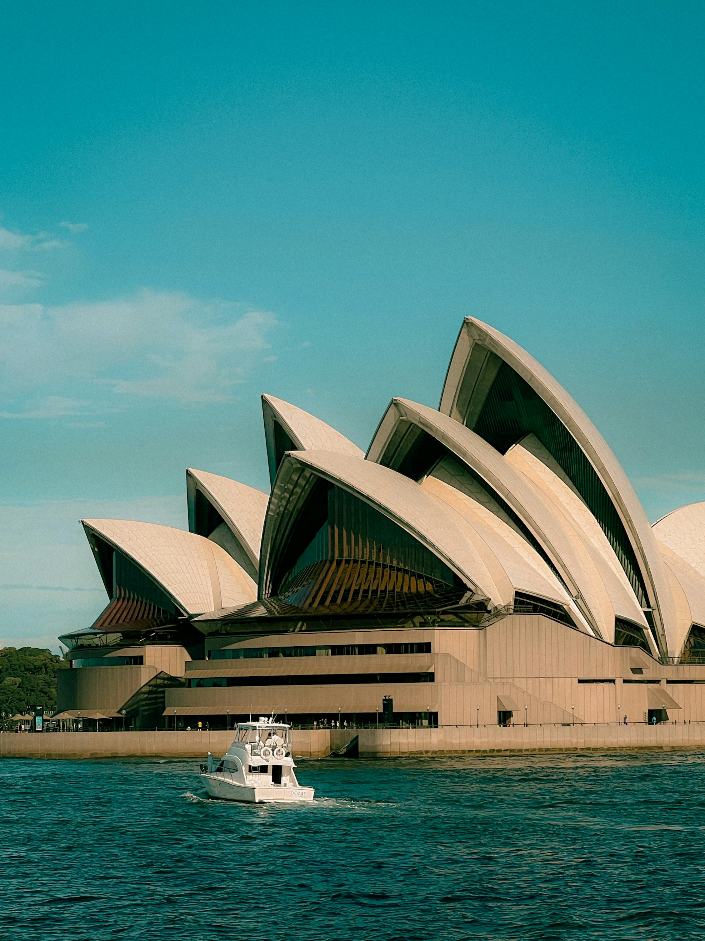 A boat in the water near a large building photo – Free Sydney opera ...