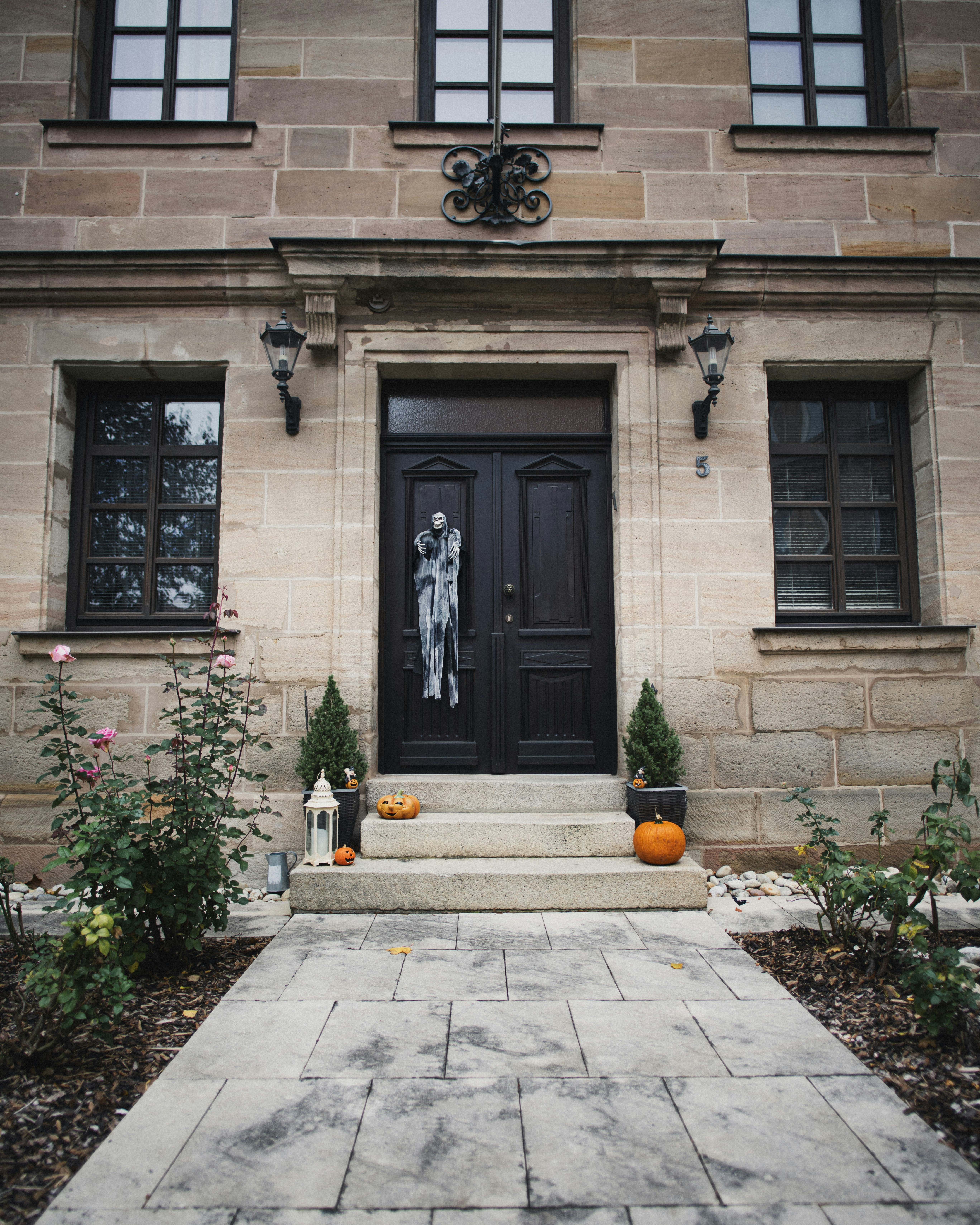 Midnight Welcome: Ghost on a Pumpkin-Decorated Doorway